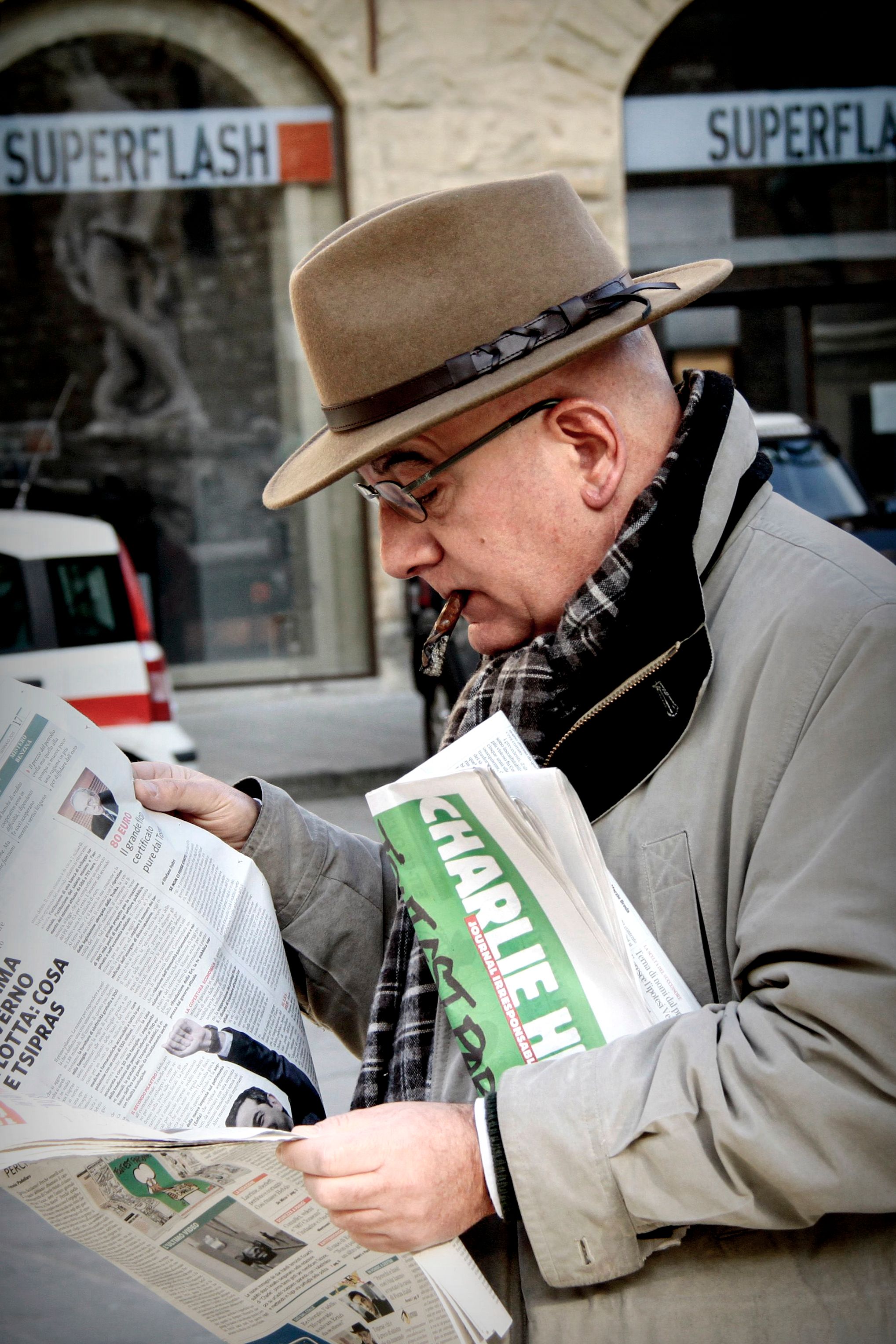 Man Reading Newspaper on Chair on Dirt Road · Free Stock Photo