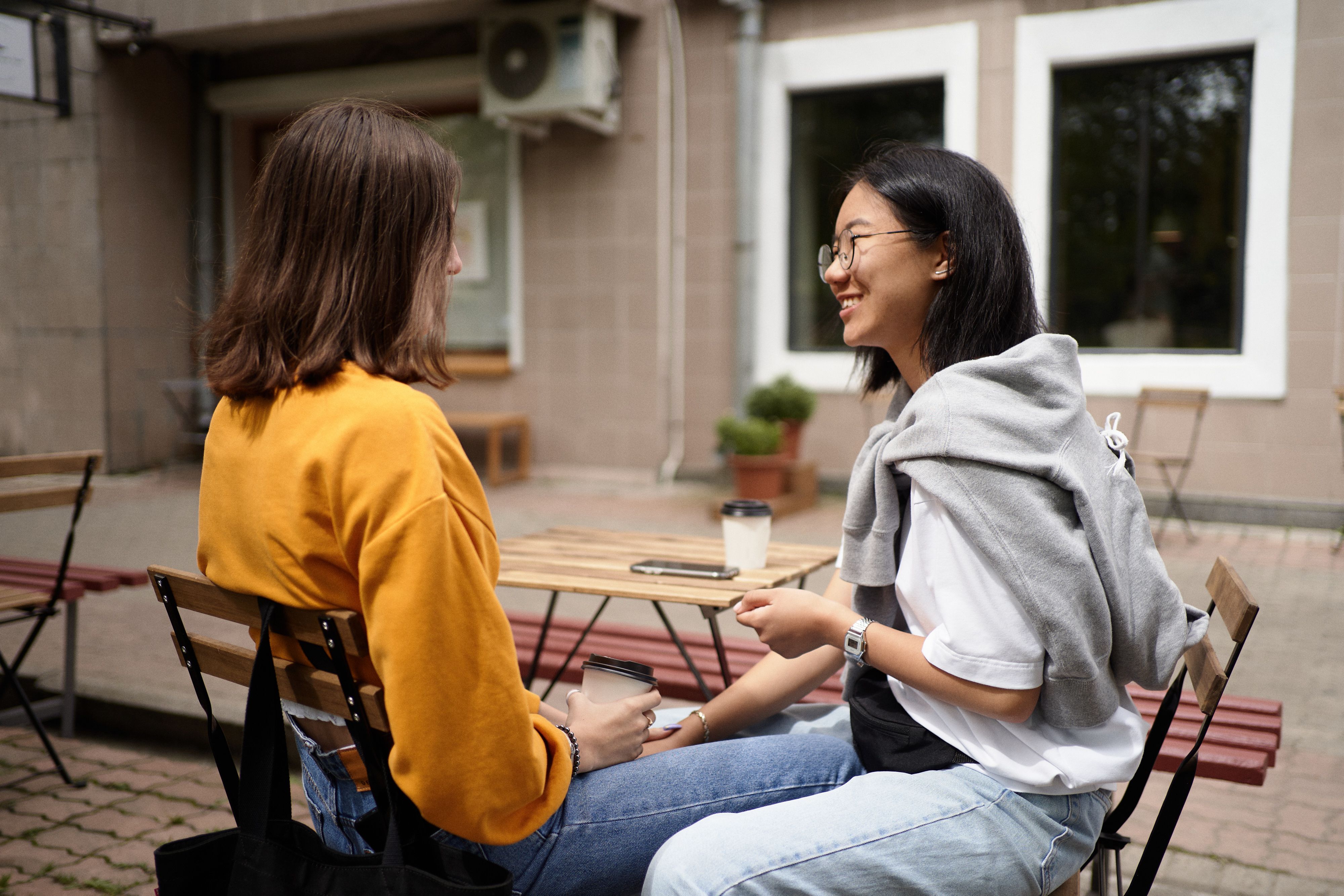 Women Talking by Table · Free Stock Photo
