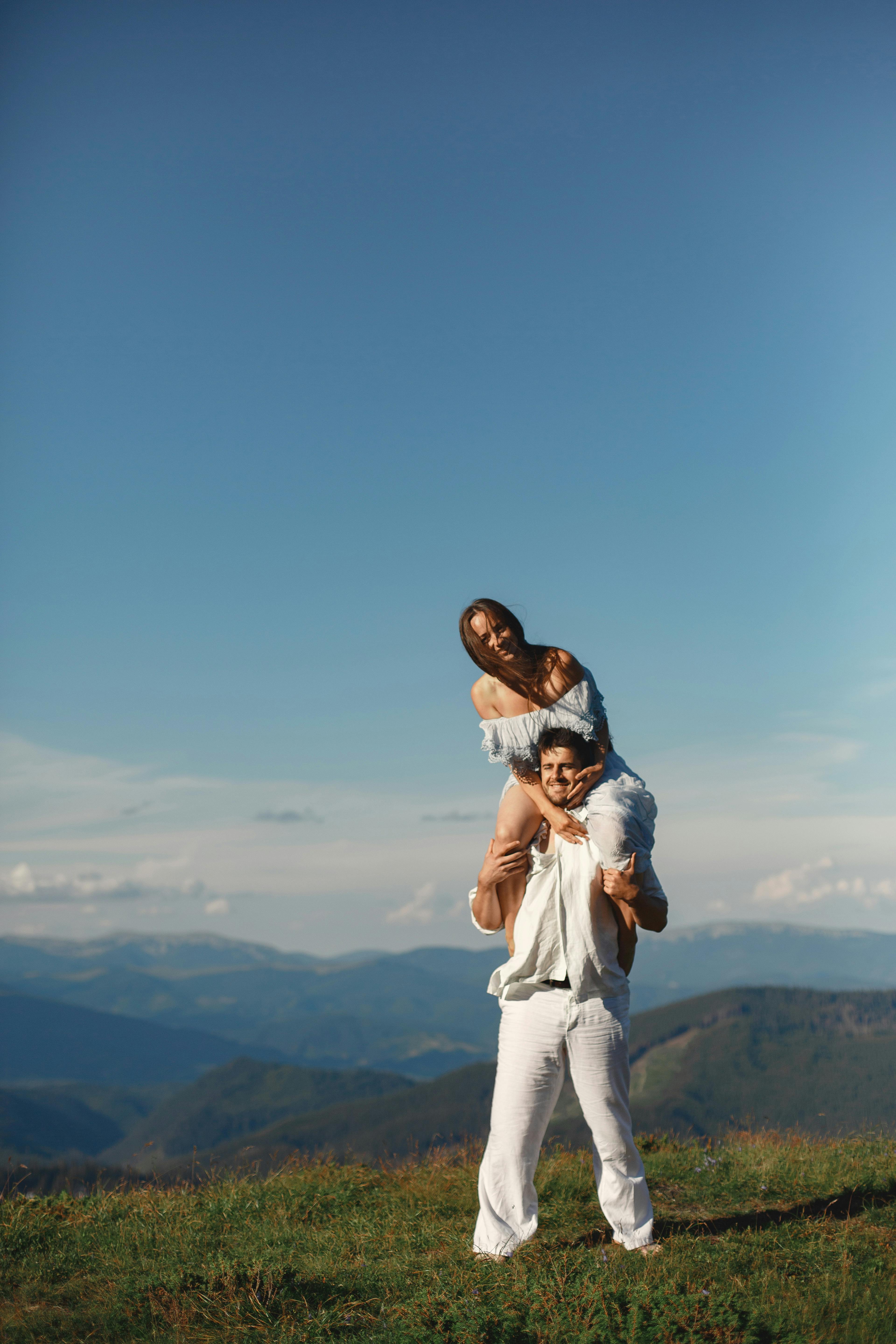 Man Carrying Woman on Back · Free Stock Photo
