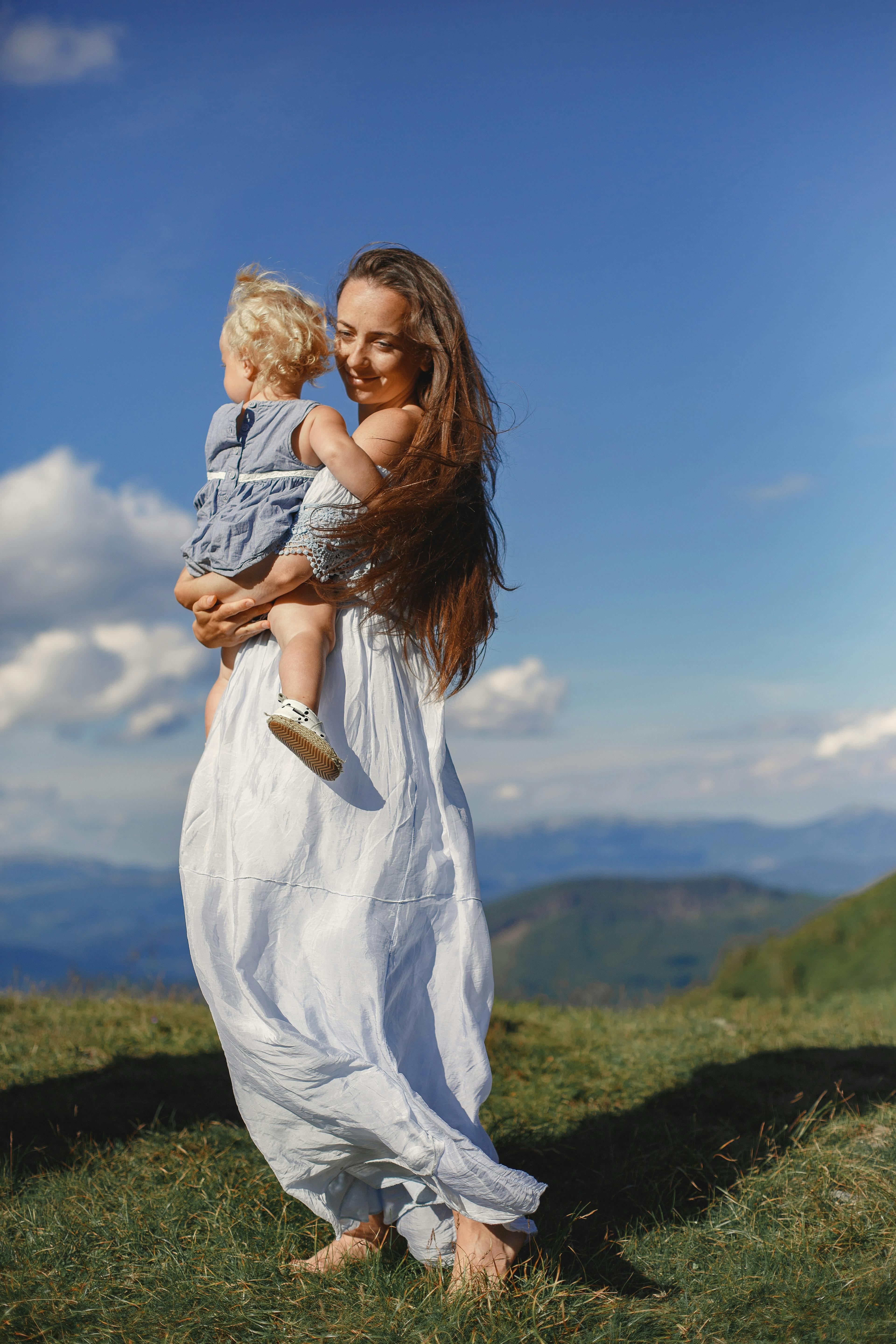 Woman Carrying Her Daughter · Free Stock Photo