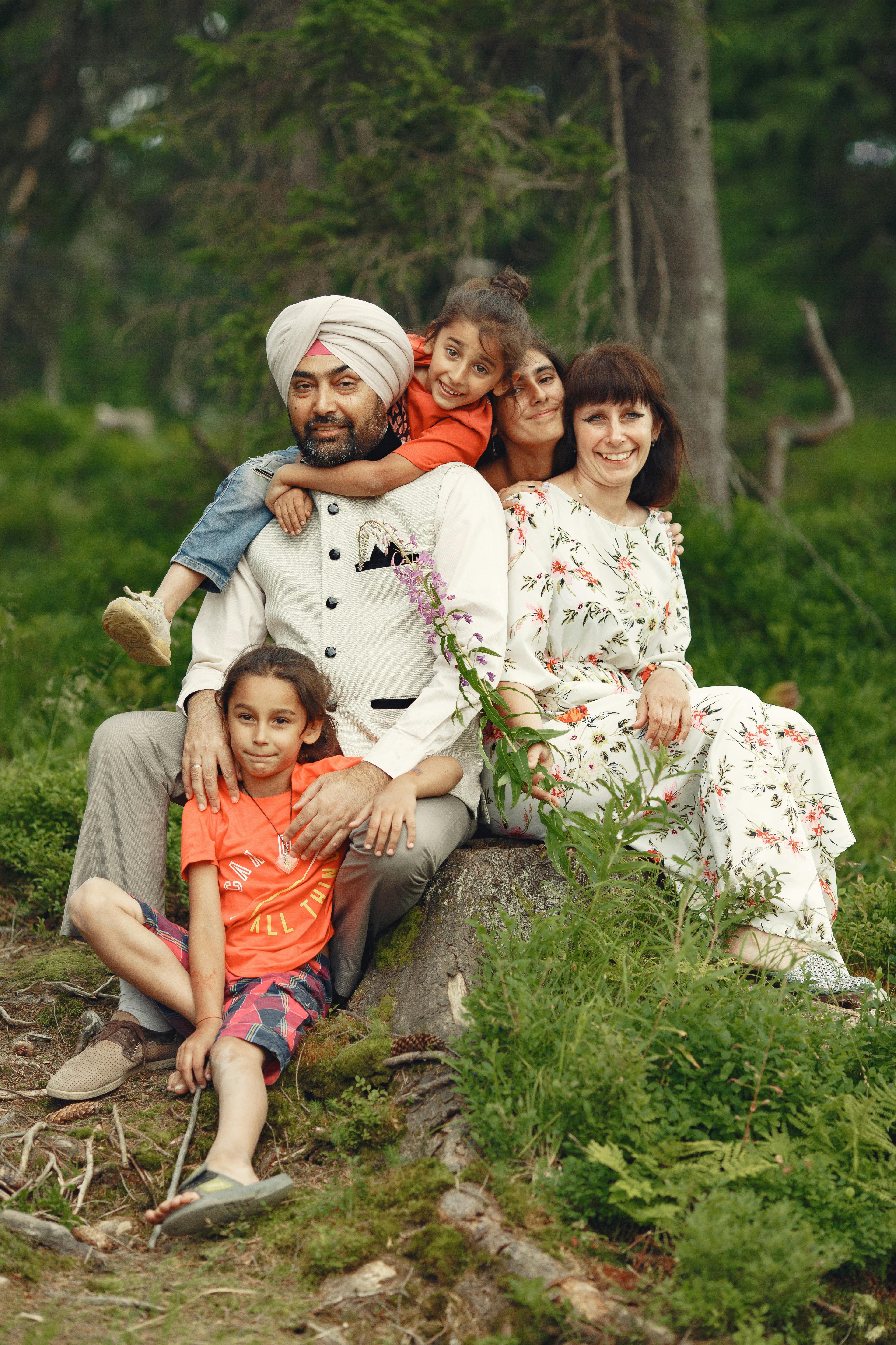 Family Sitting on a Tree Stump · Free Stock Photo