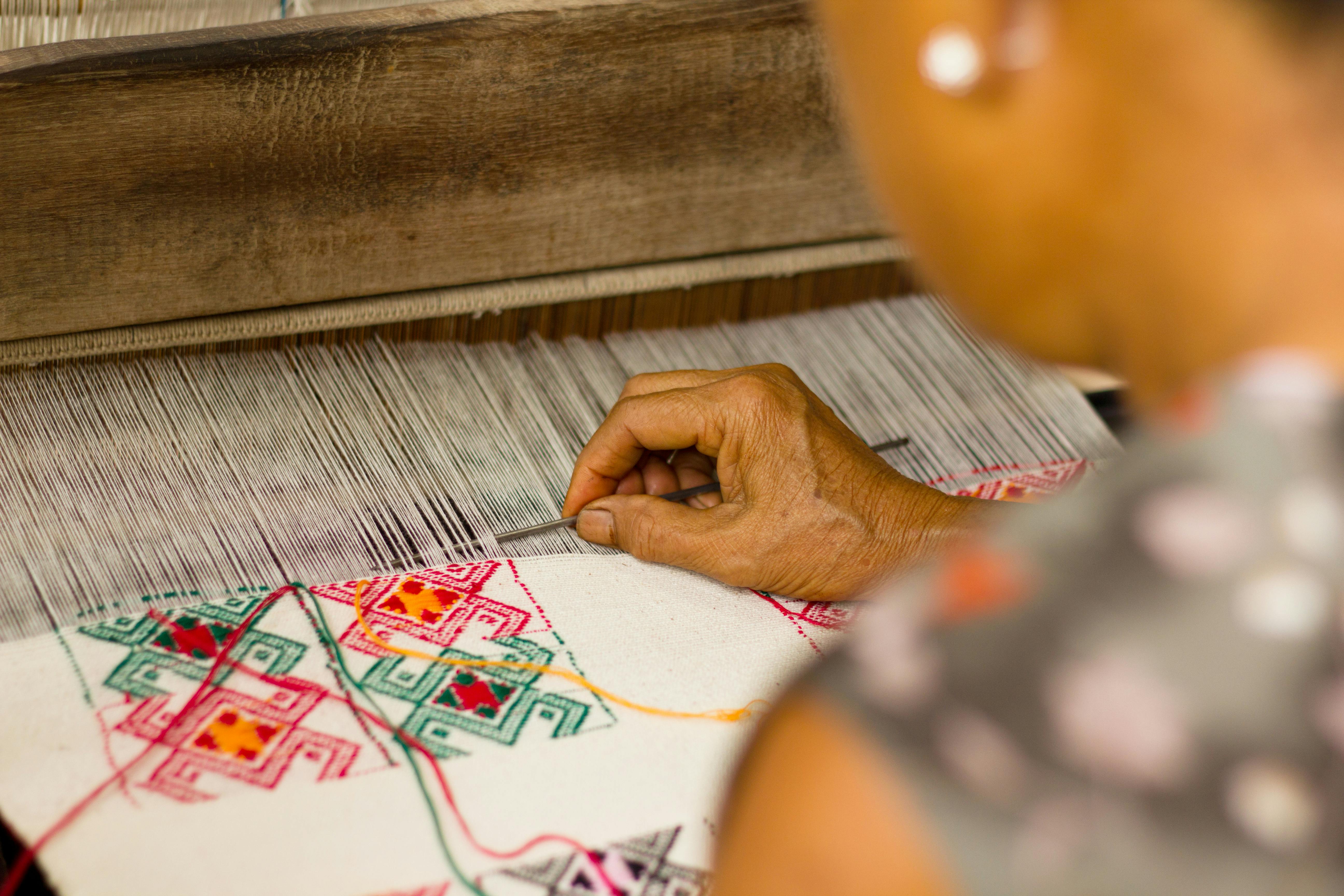 A Woman Weaving a Fabric · Free Stock Photo