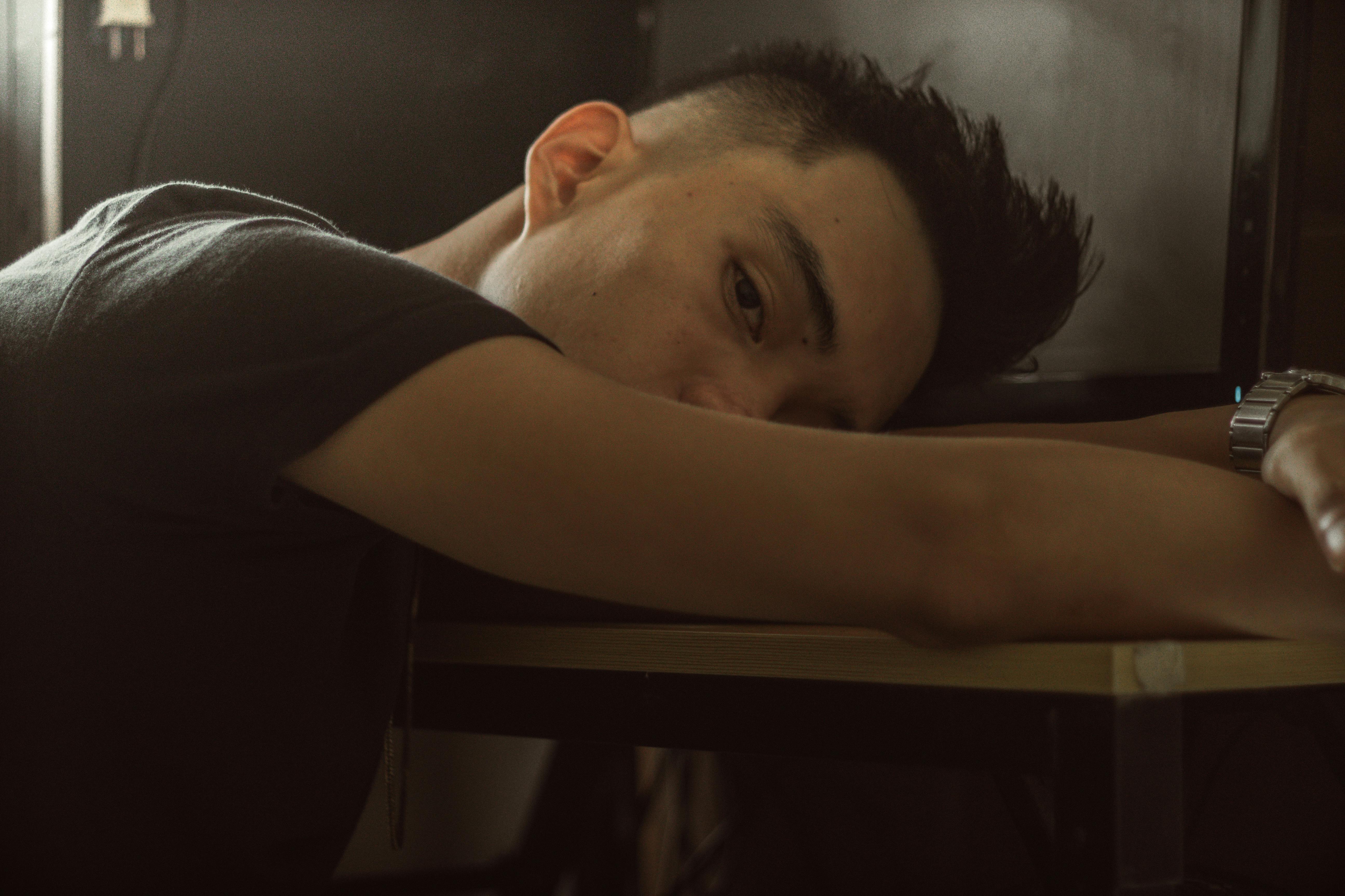 Crop man resting on table · Free Stock Photo