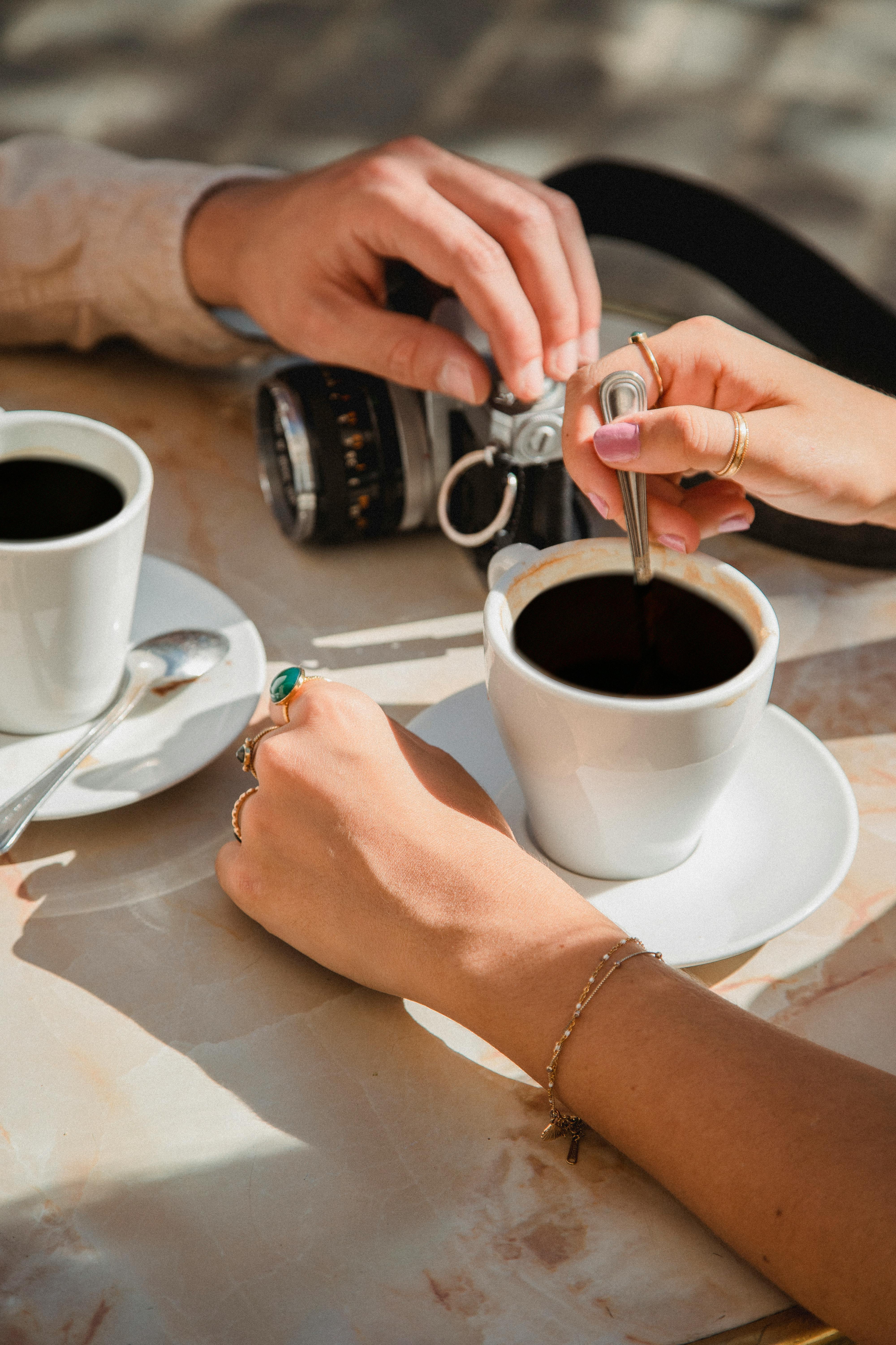 Person Stirring Coffee in a Mug · Free Stock Photo