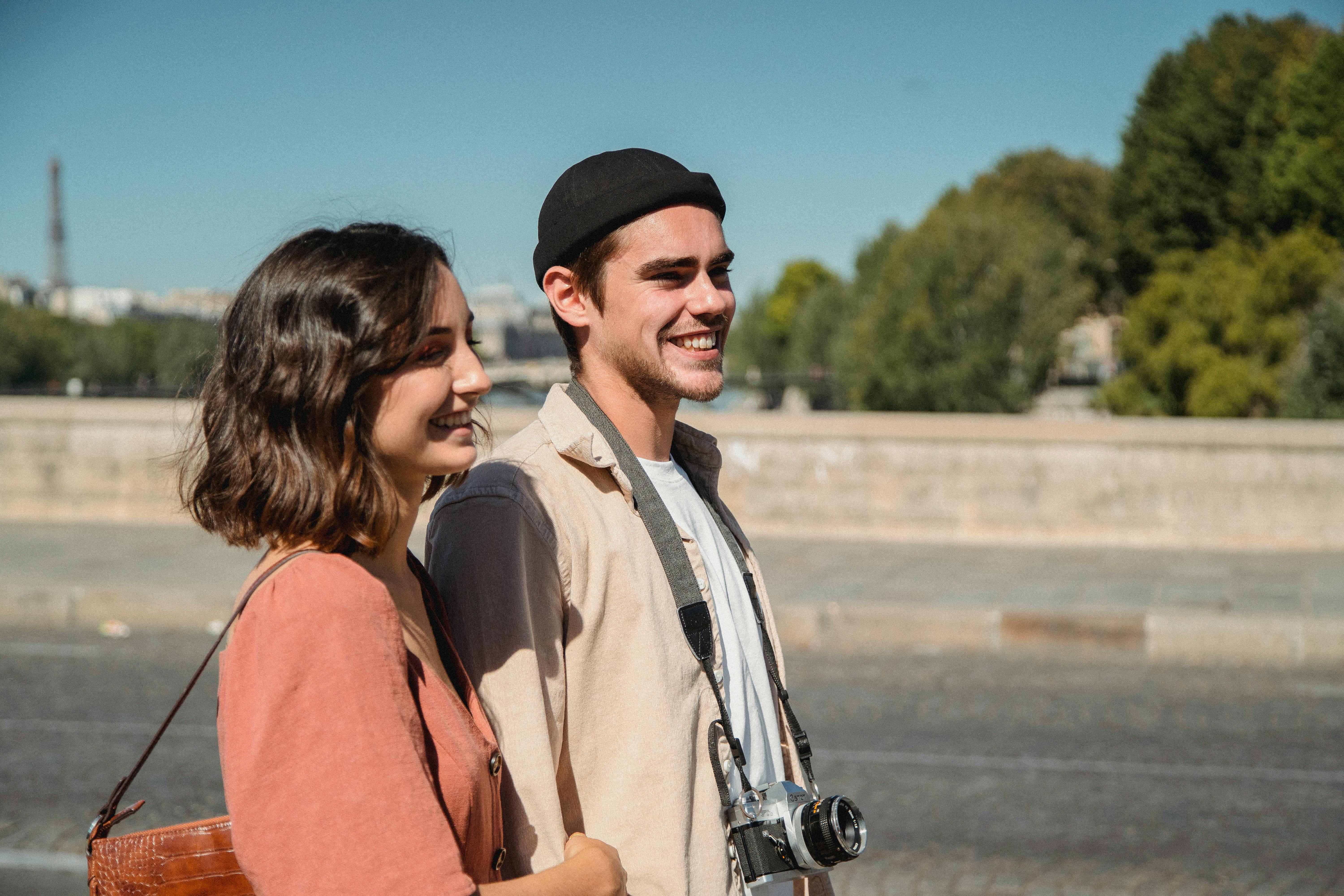 Woman Holding on to Man's Arm While Walking · Free Stock Photo