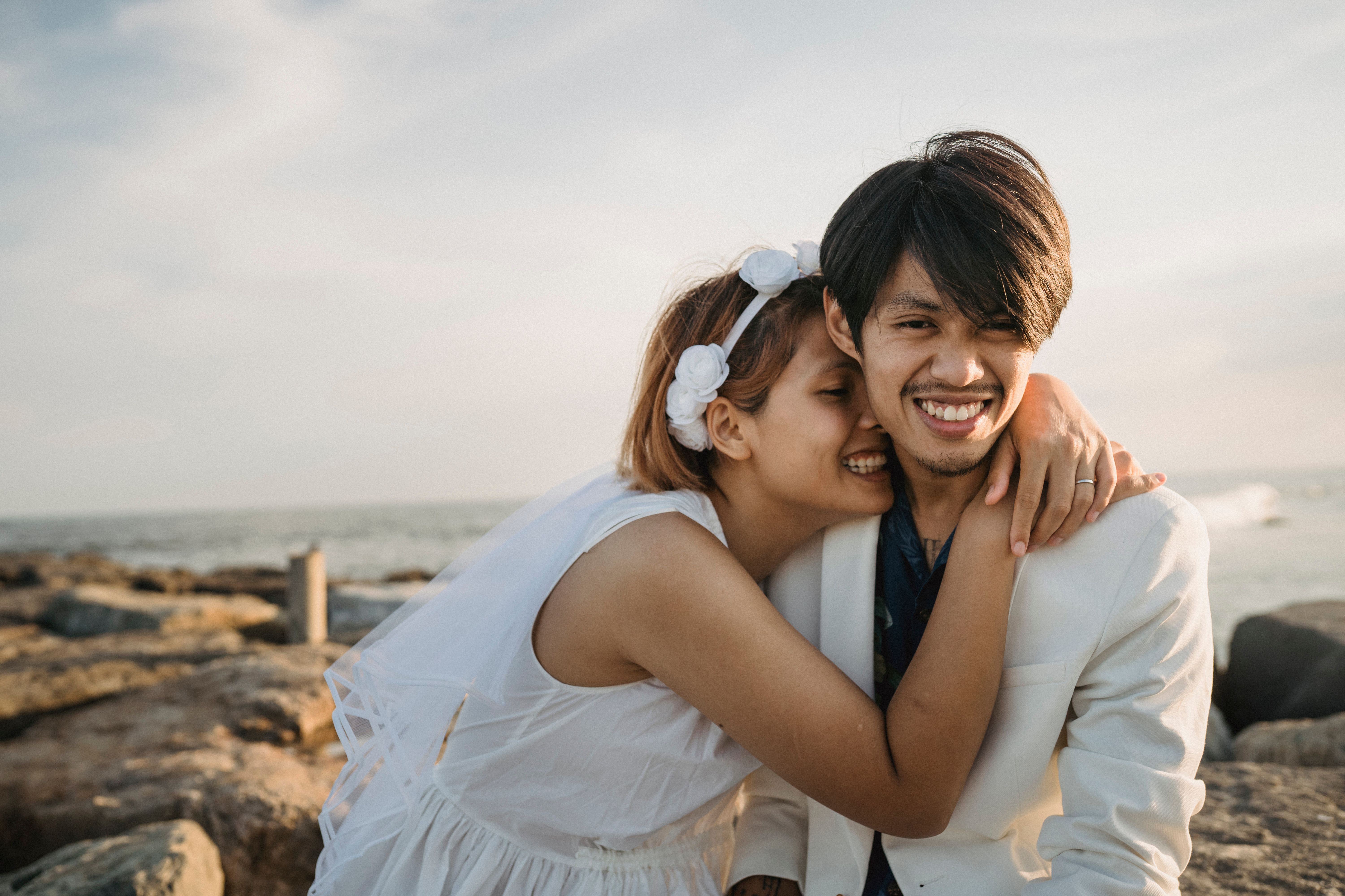 Man Hugging Man in White Suit · Free Stock Photo