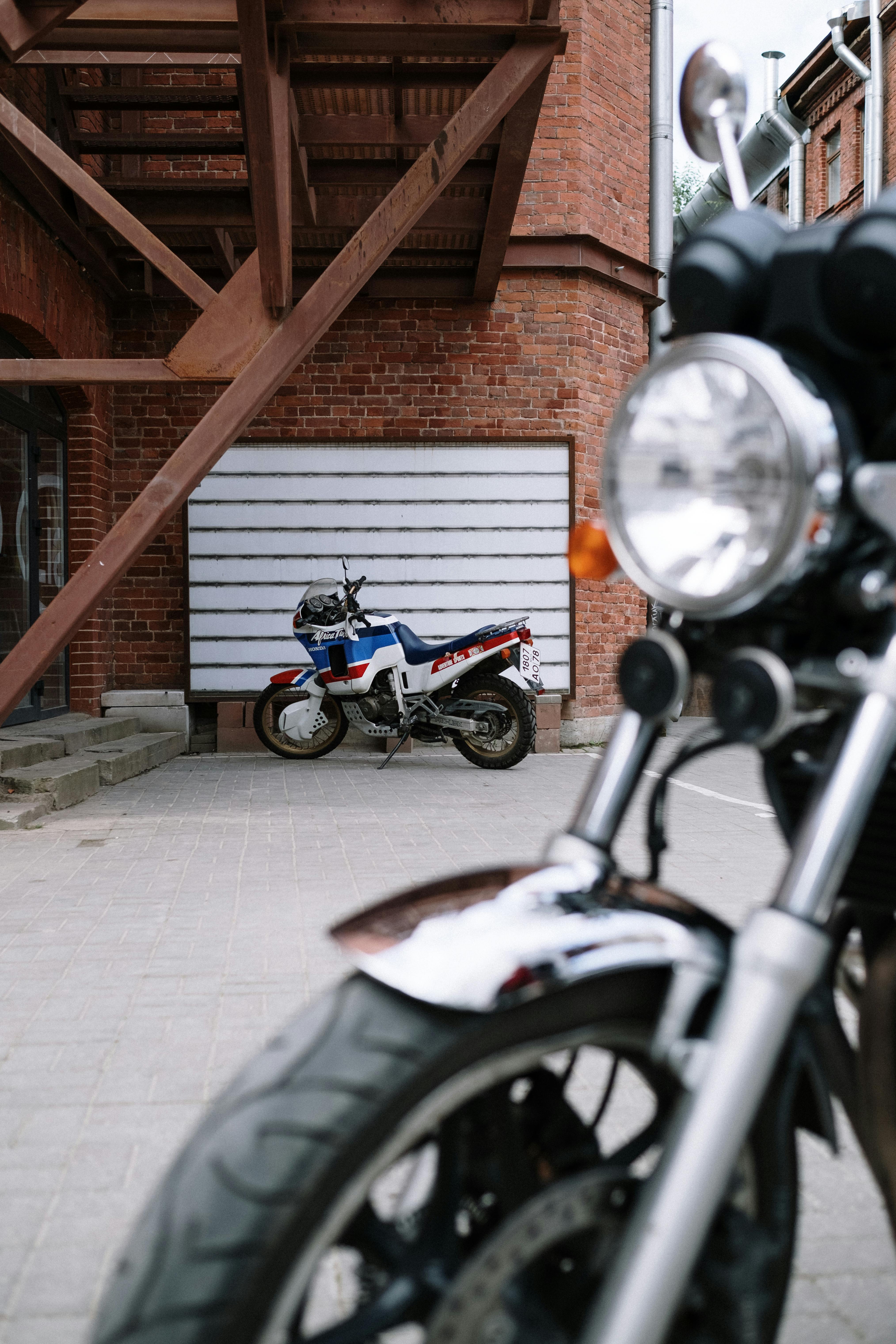 Shiny Motorcycle Parked Beside a House · Free Stock Photo