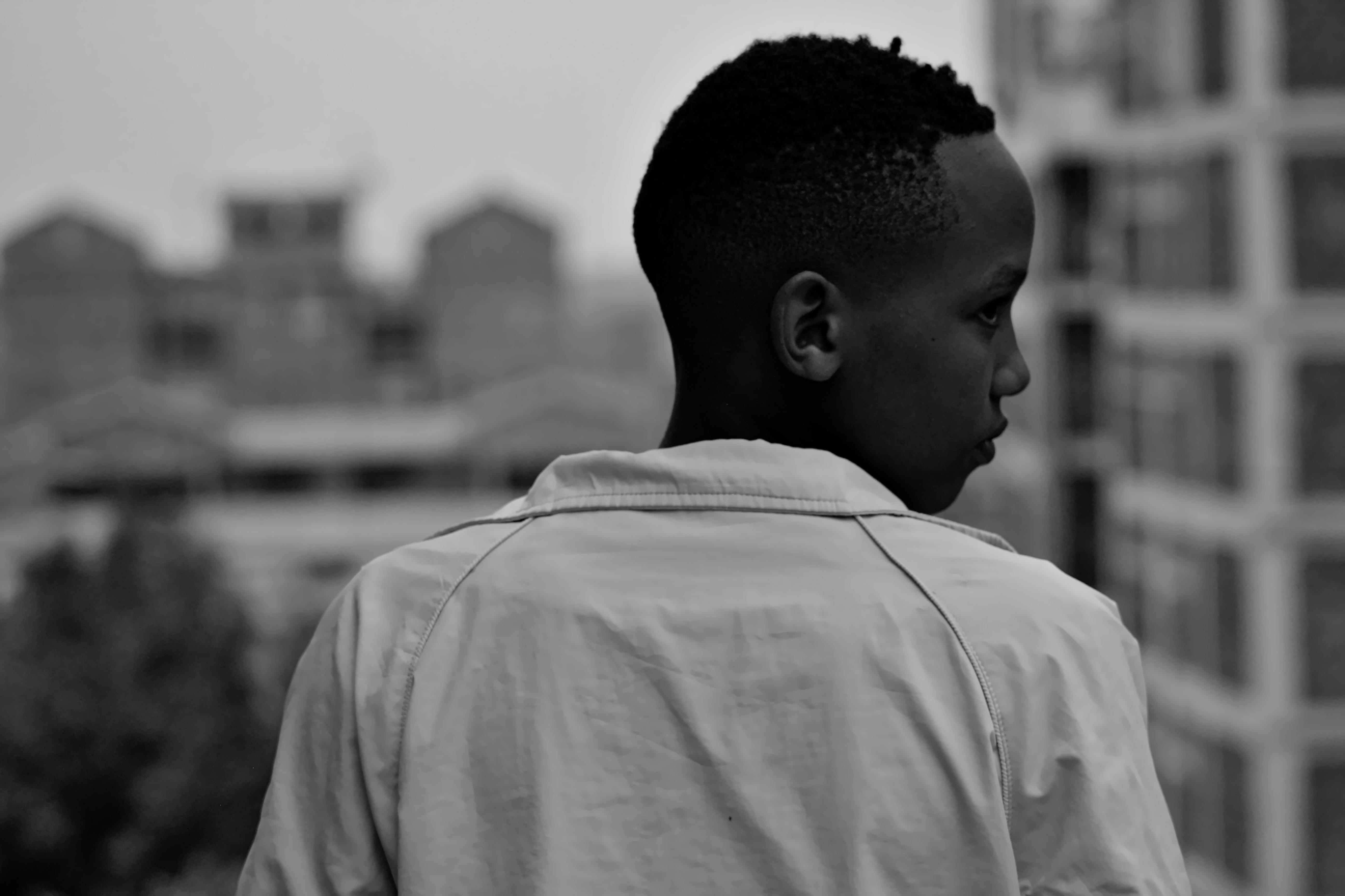 A Boy Looking Over His Shoulder · Free Stock Photo