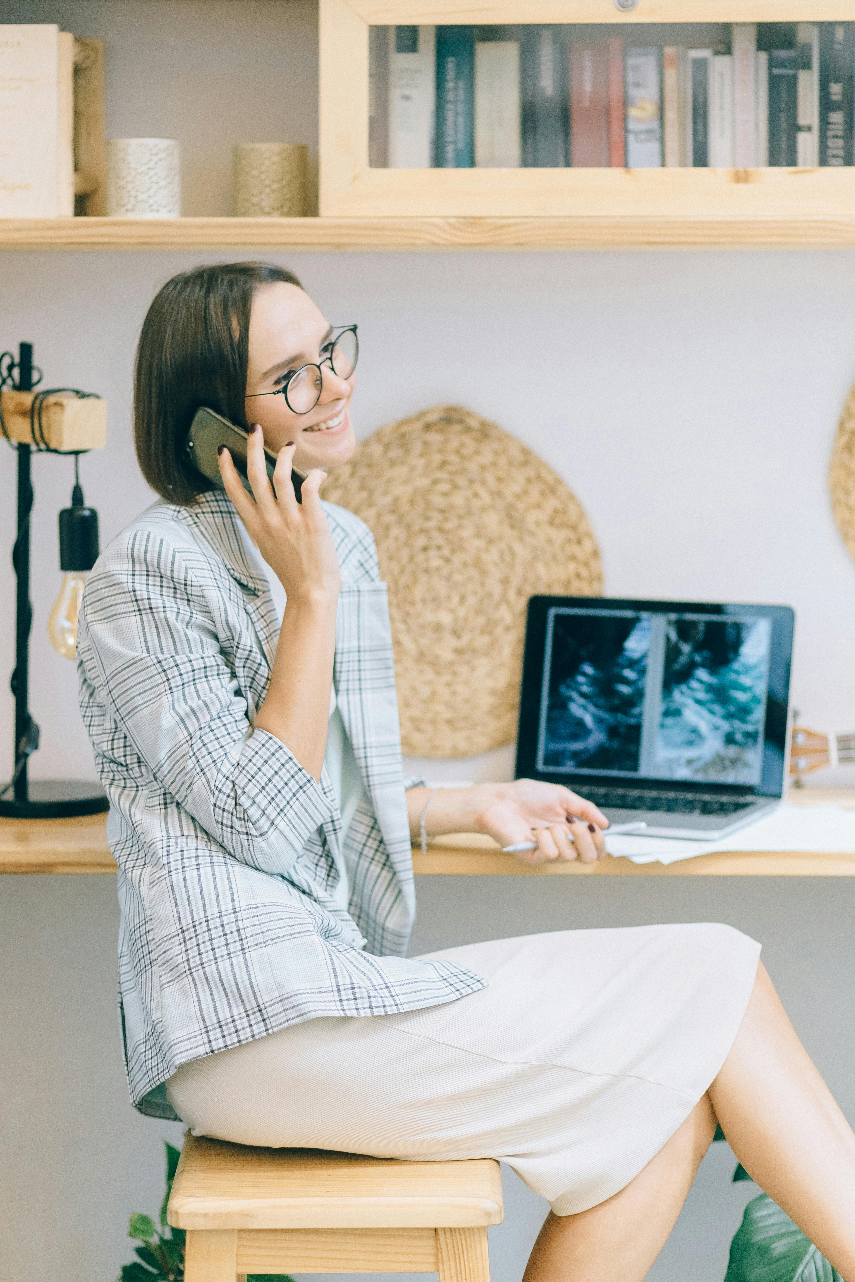 Woman Smiling While Talking on the Phone · Free Stock Photo
