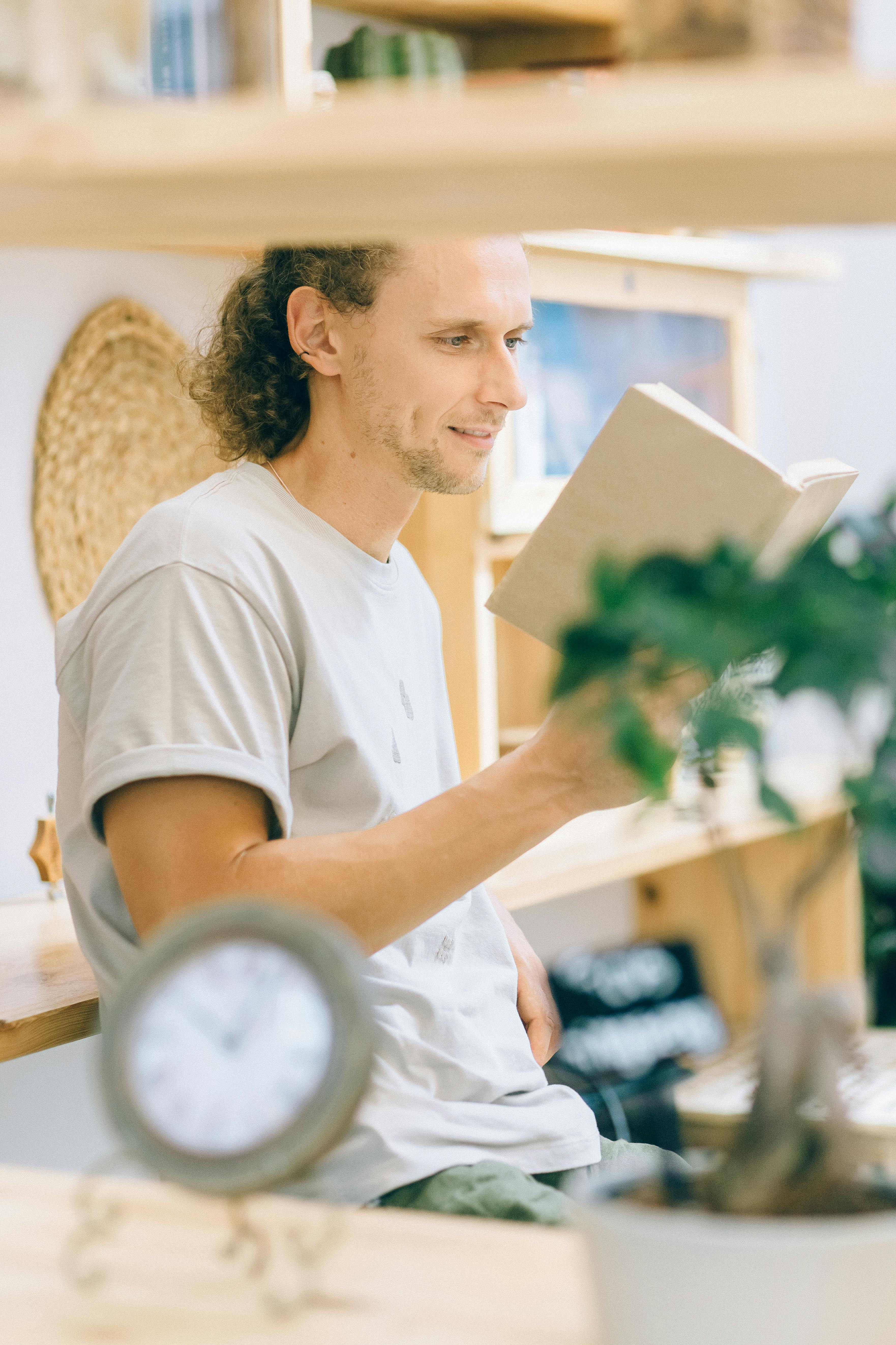 Person Reading a Book and having Tea · Free Stock Photo