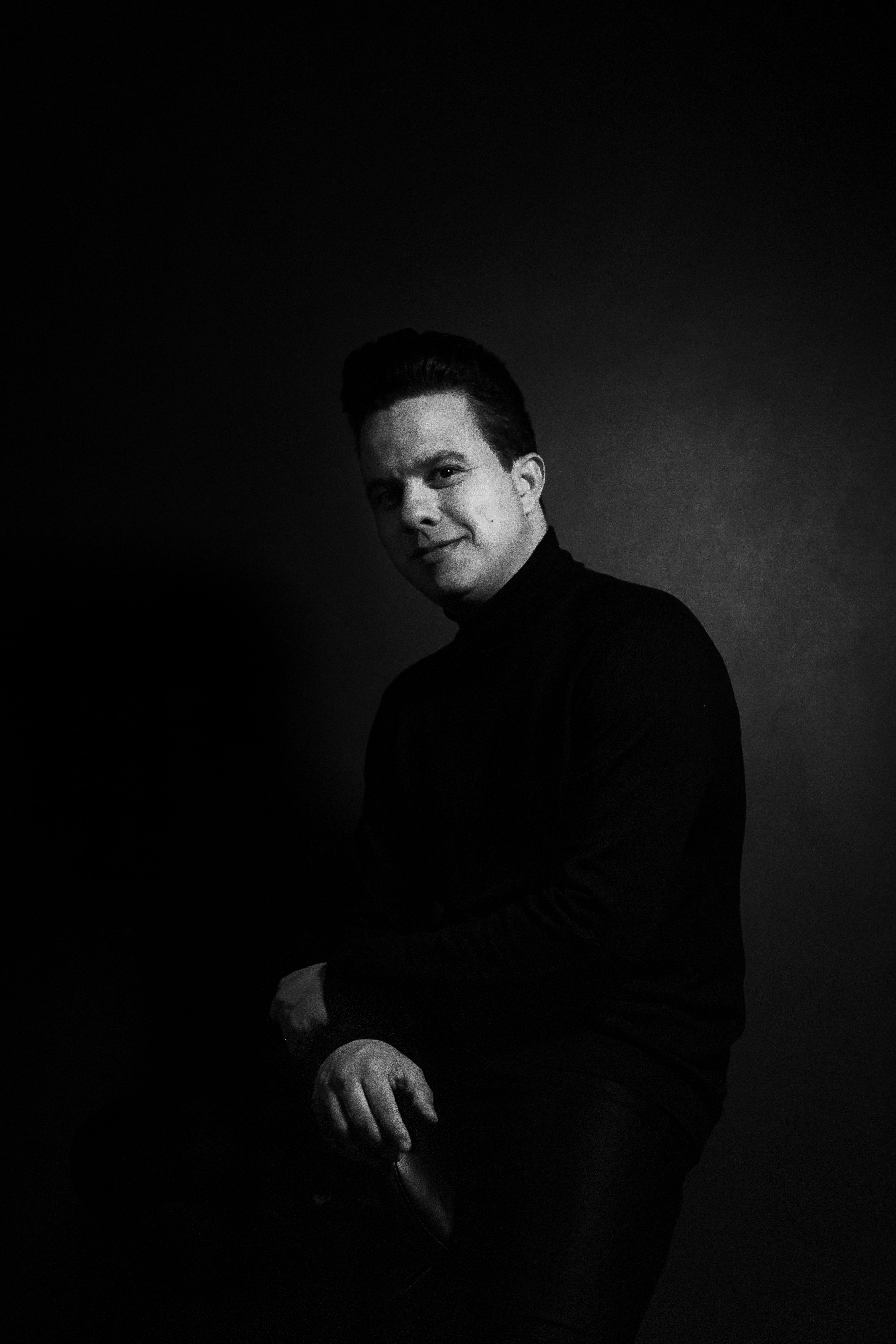 Grayscale Photo of a Stylish Man Posing with a Dog · Free Stock Photo