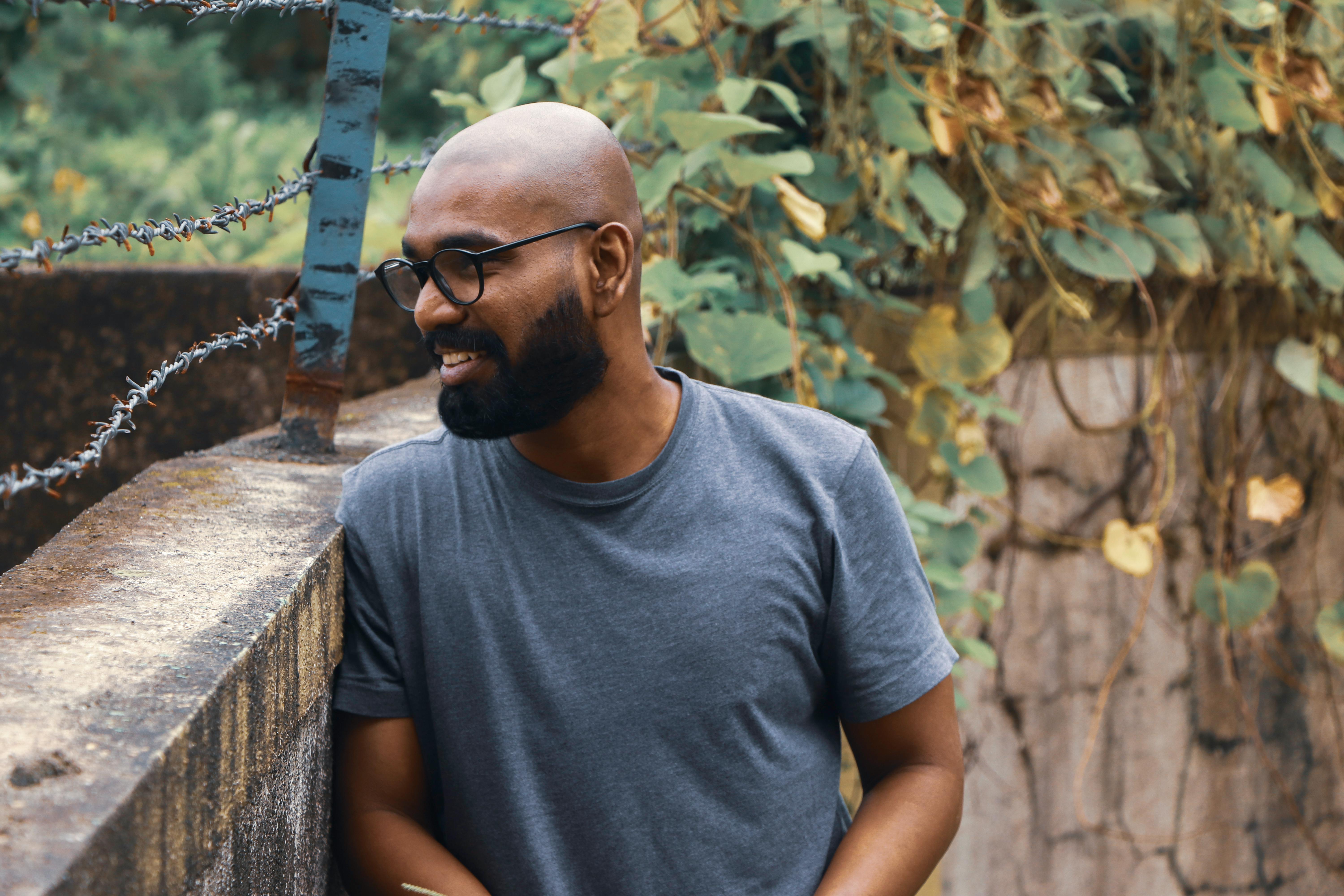 A Man Smiling While Texting · Free Stock Photo