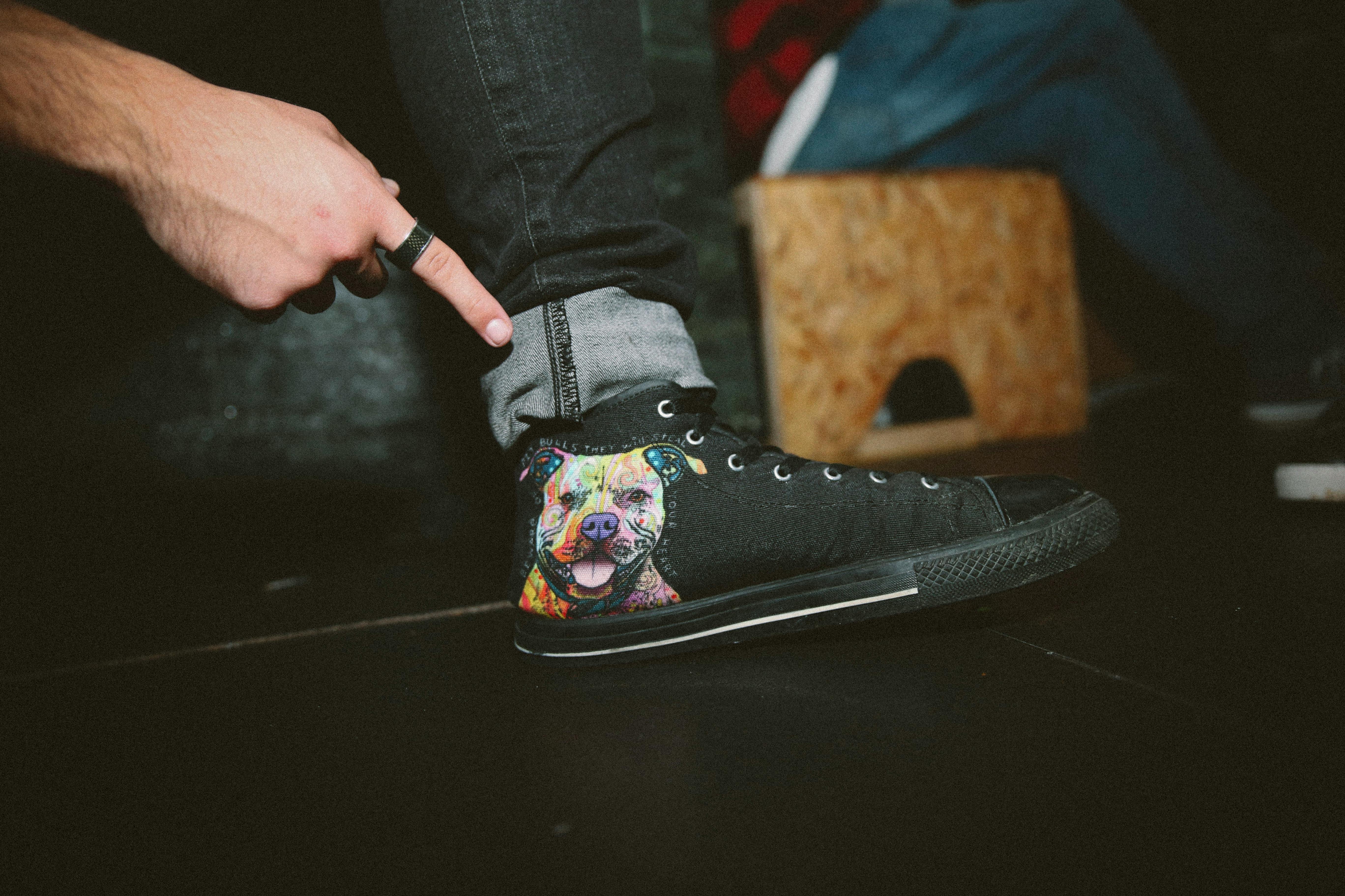 Hand Showing Design on Shoe · Free Stock Photo