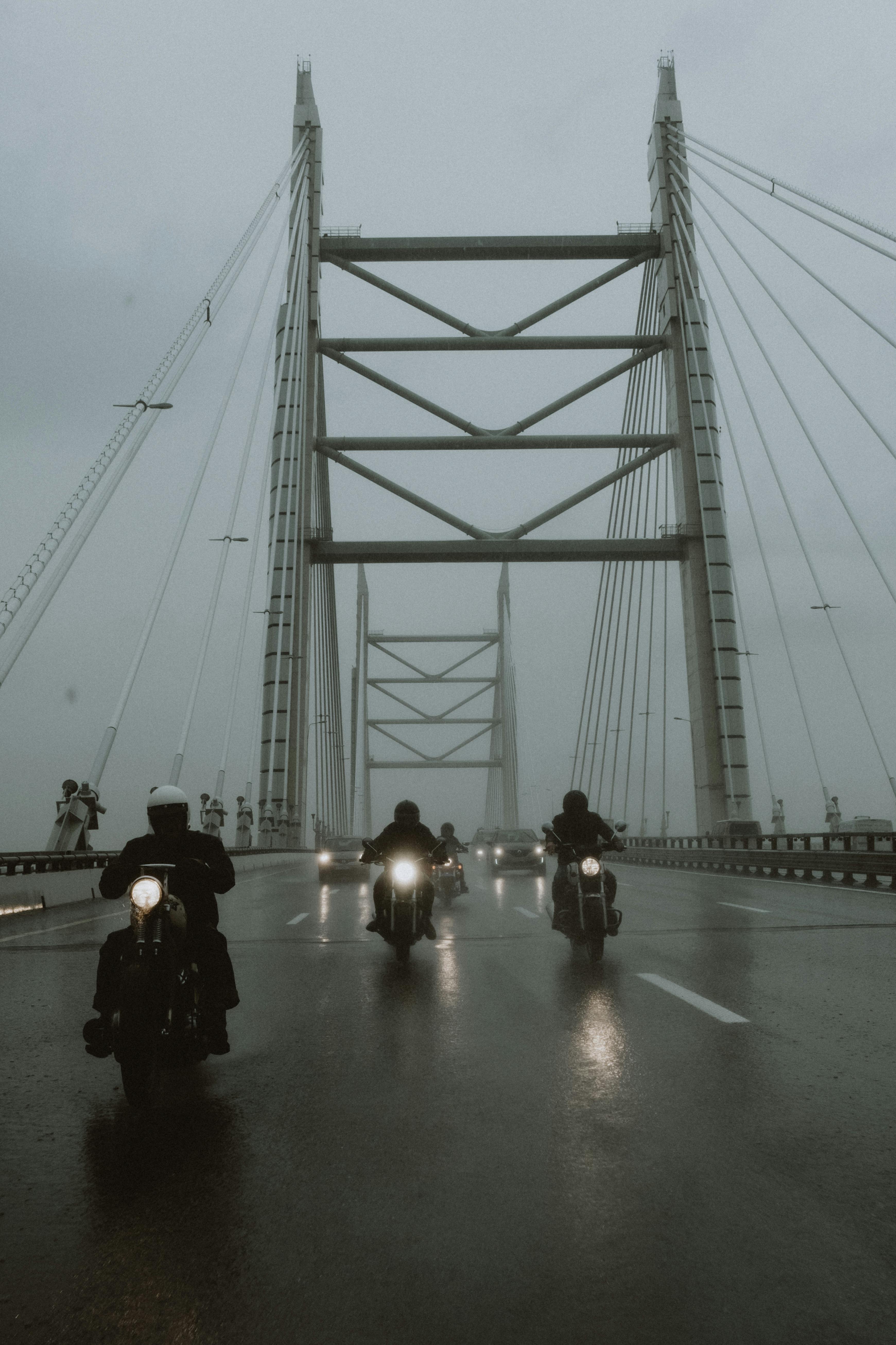 Motorcycle Riders Passing a Bridge · Free Stock Photo
