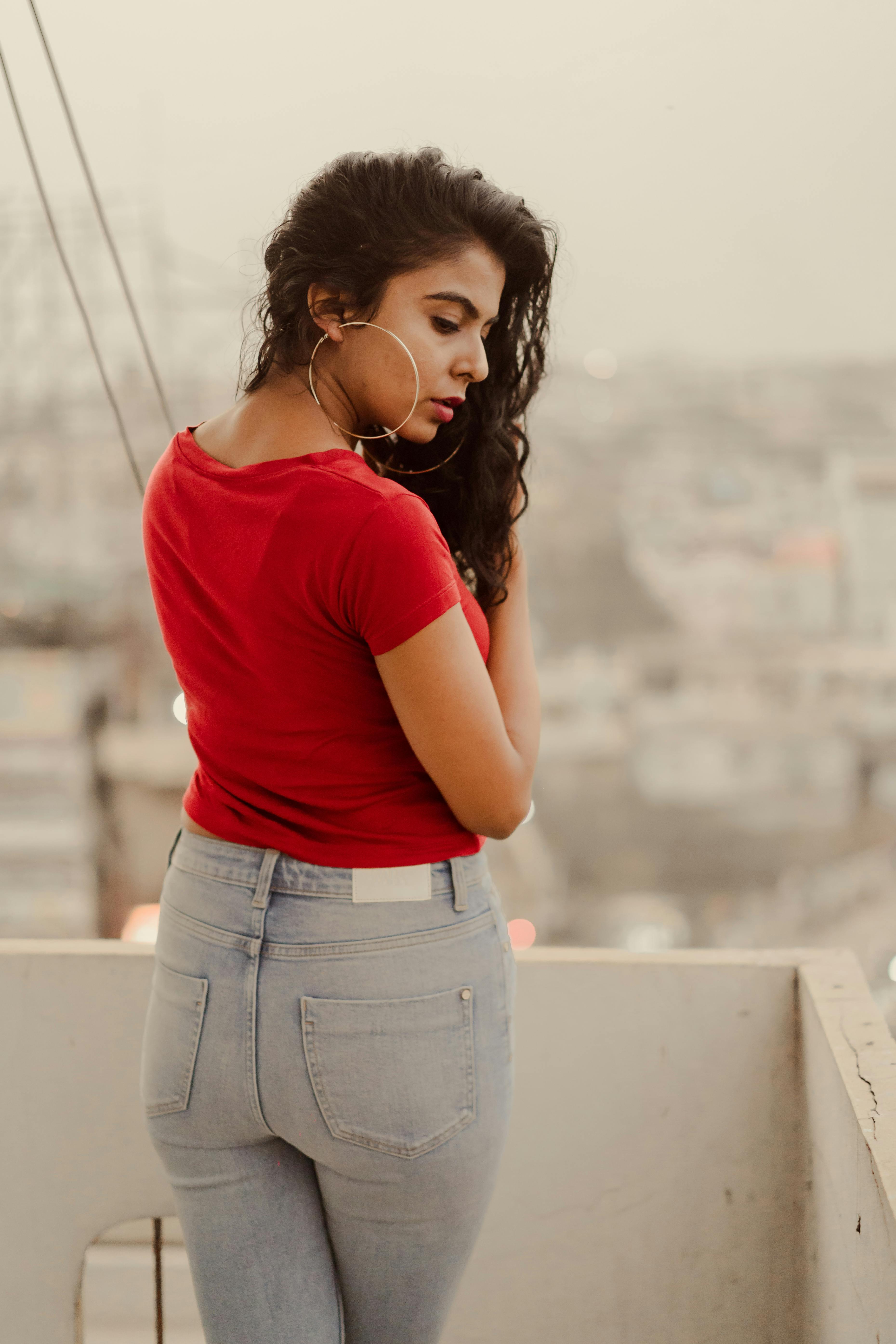 A Woman in Curly Hair Wearing Loop Earrings while Looking Afar · Free ...