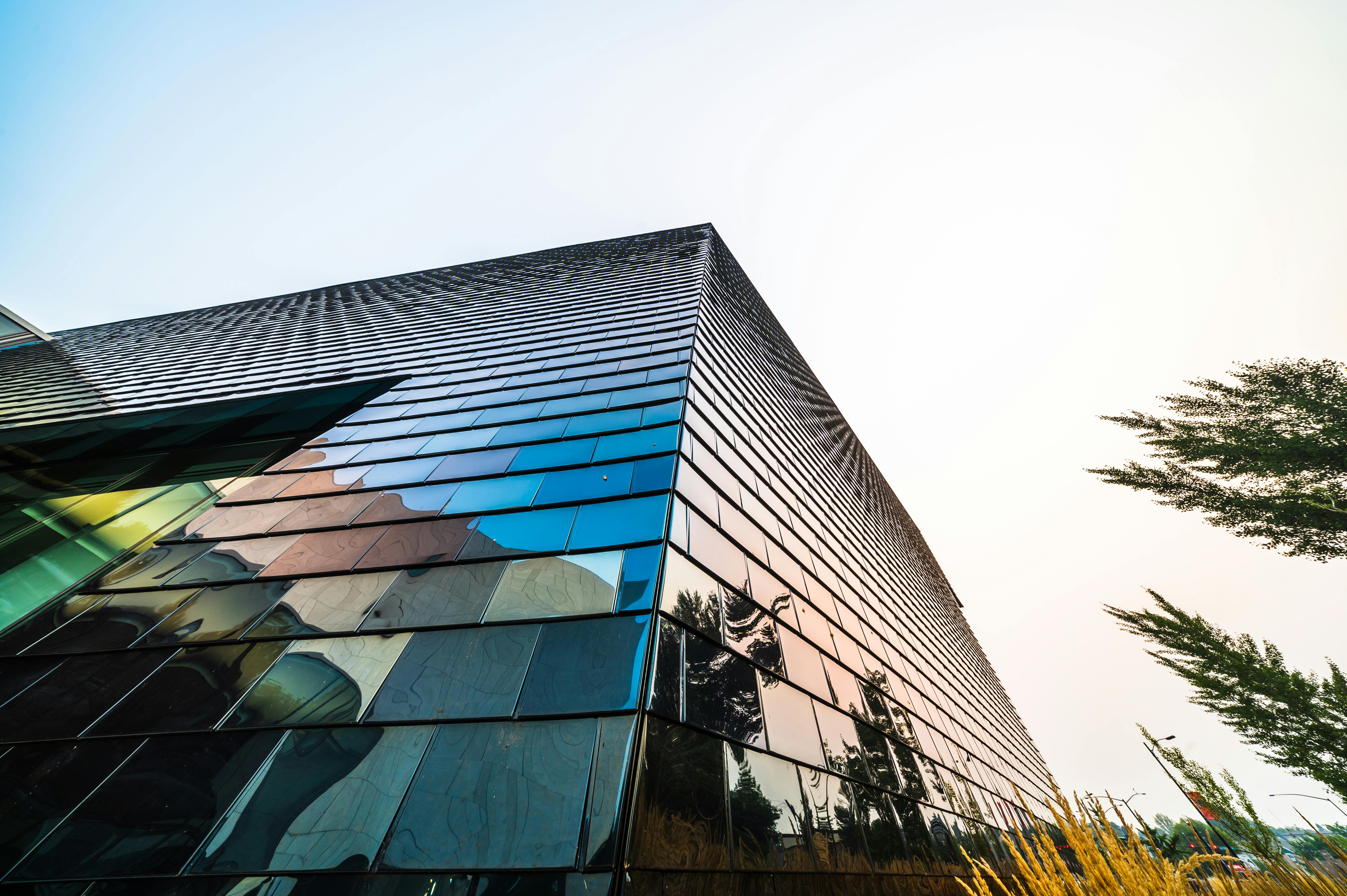 Mirrored facade of modern building at sunset · Free Stock Photo