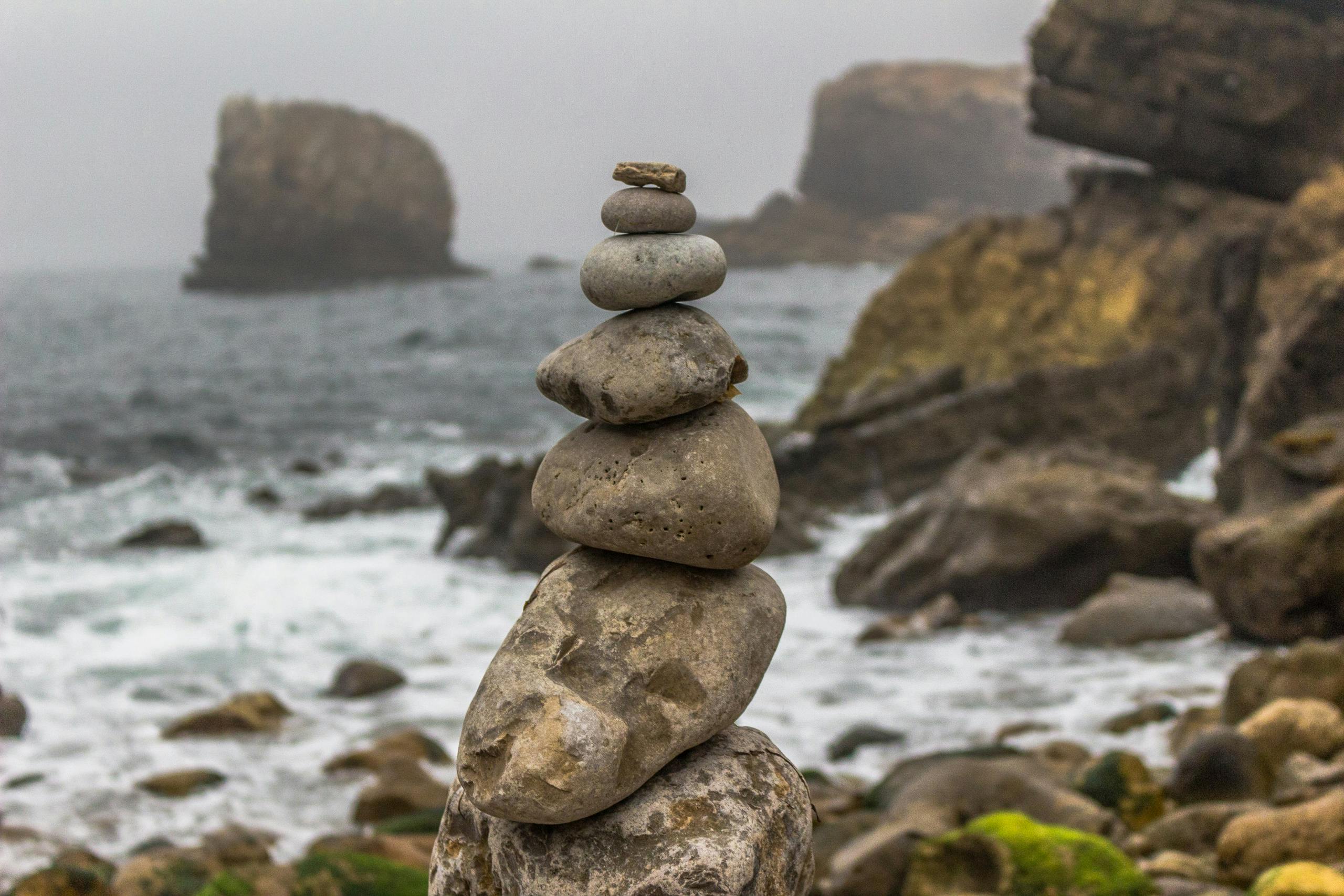 Stack of Stones Near Body of Water · Free Stock Photo