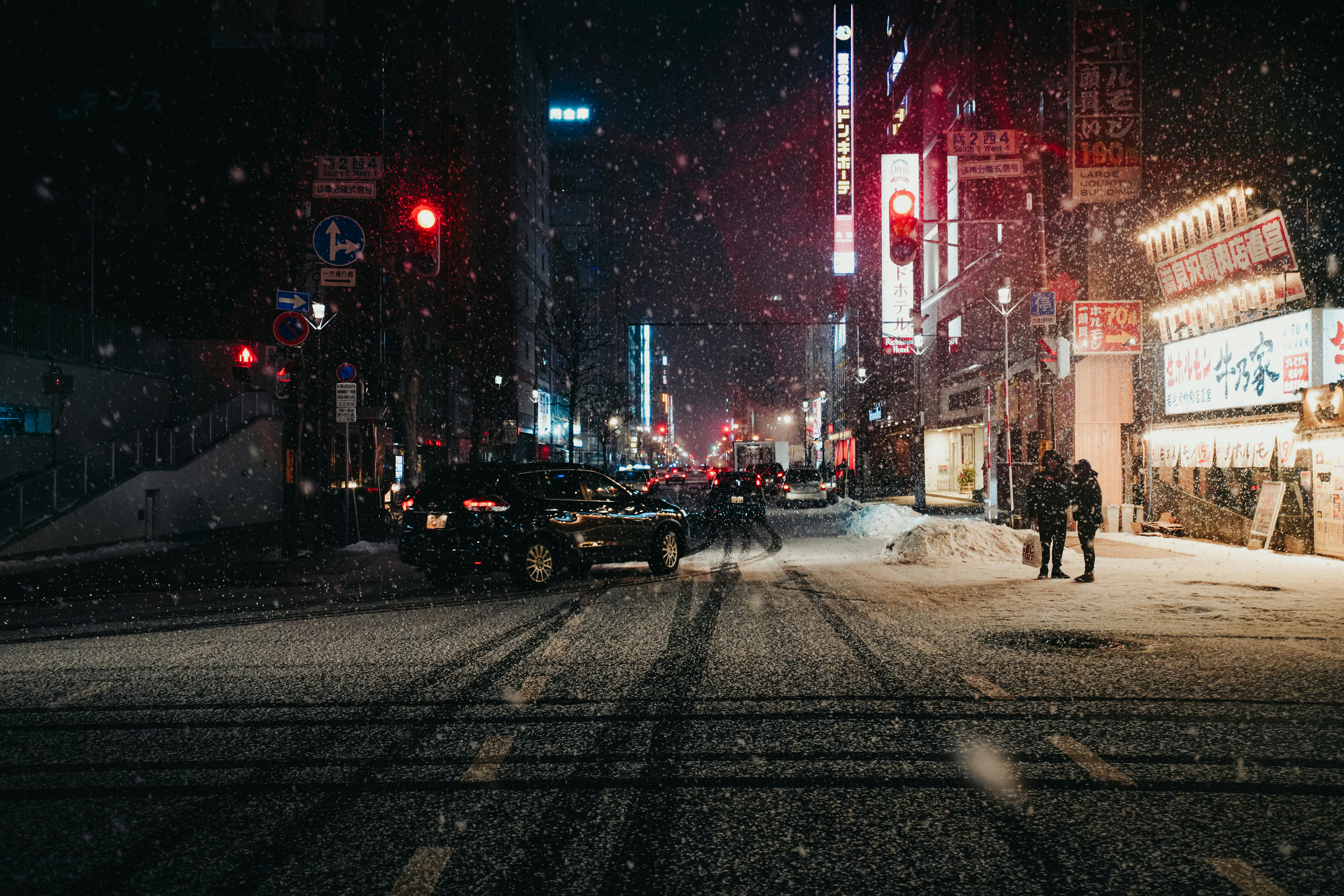 Snowing on a Busy Road During Night Time · Free Stock Photo