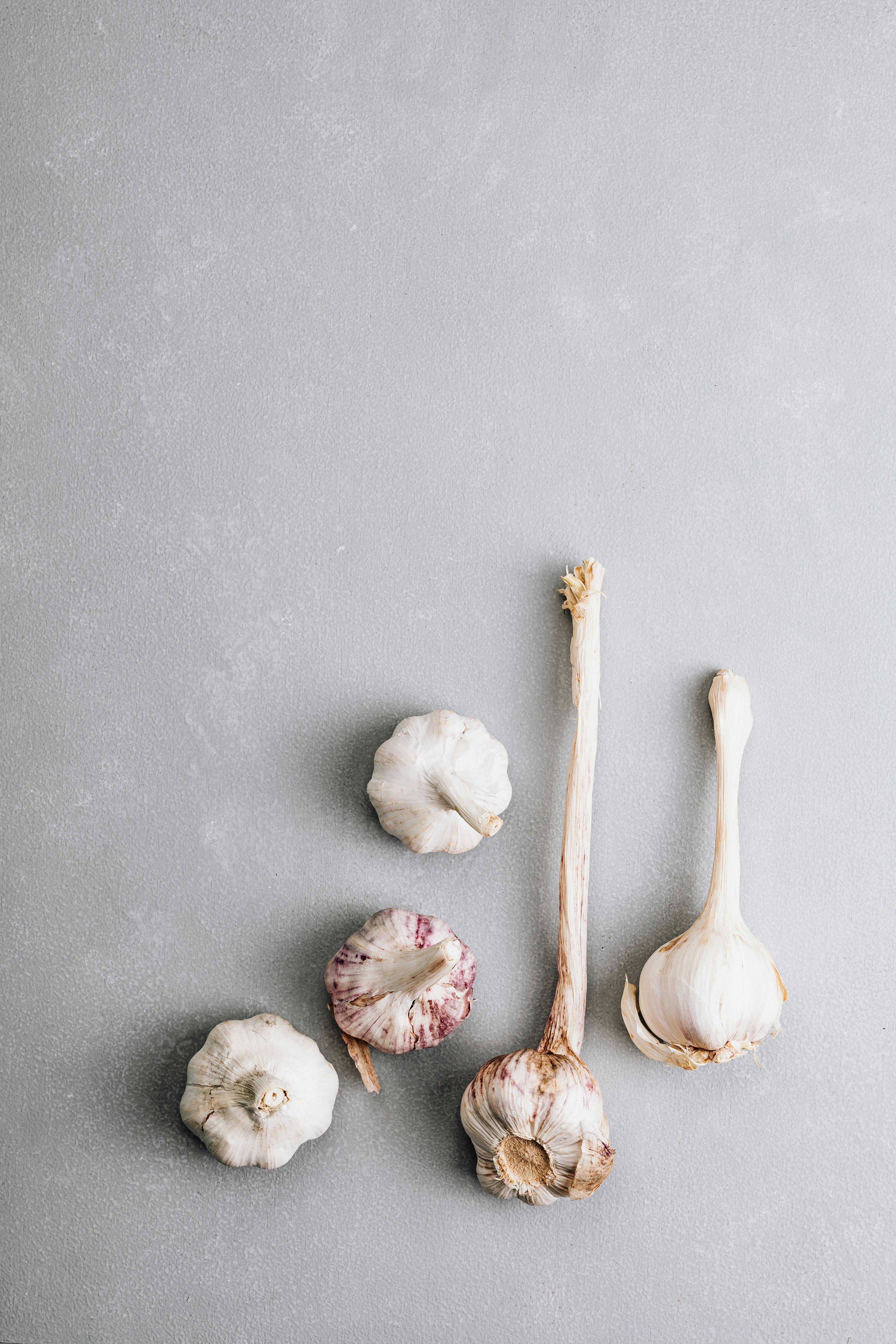 Bulbs of Garlic on a Gray Surface · Free Stock Photo