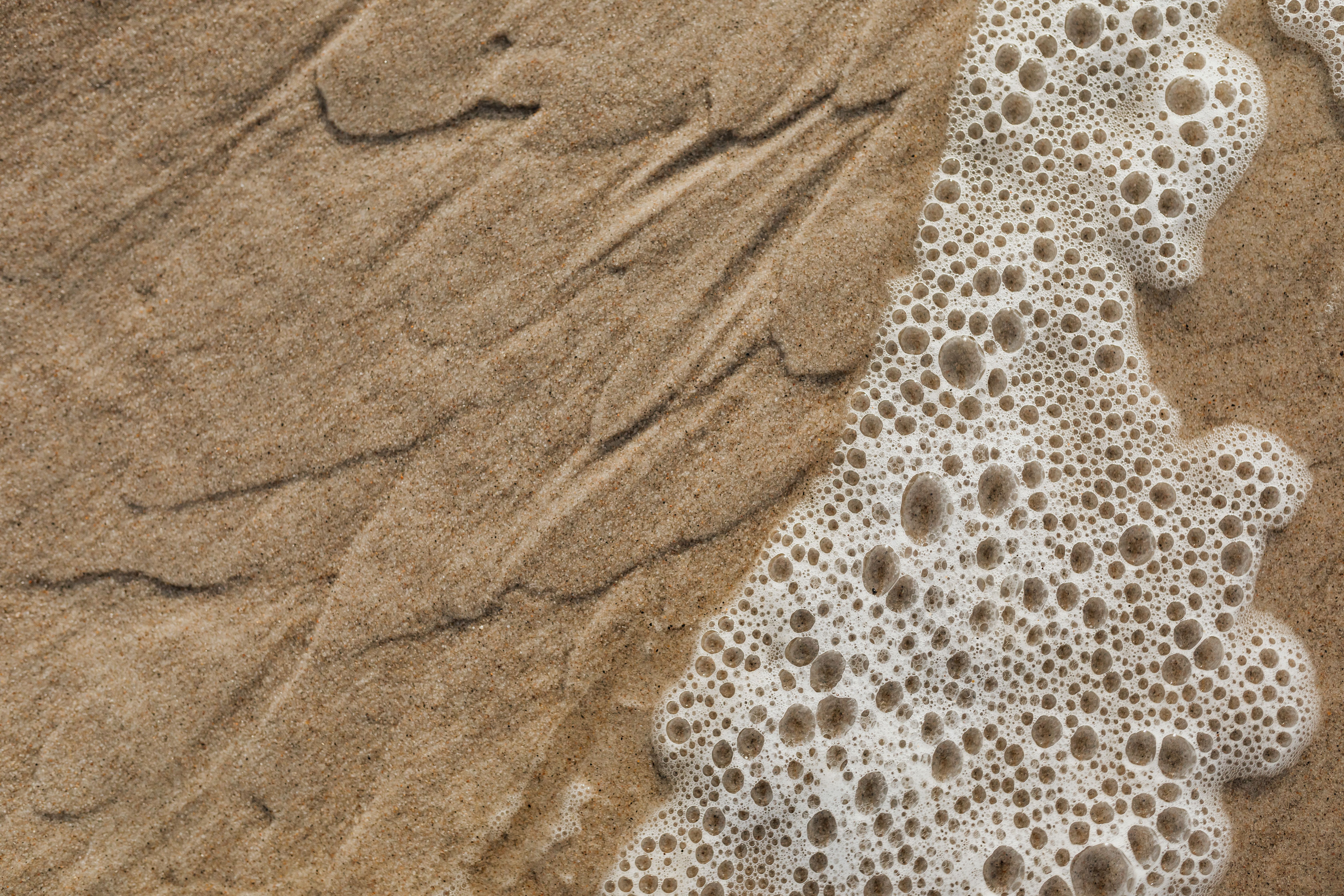 Close-Up Shot of Water Bubbles on the Sand · Free Stock Photo