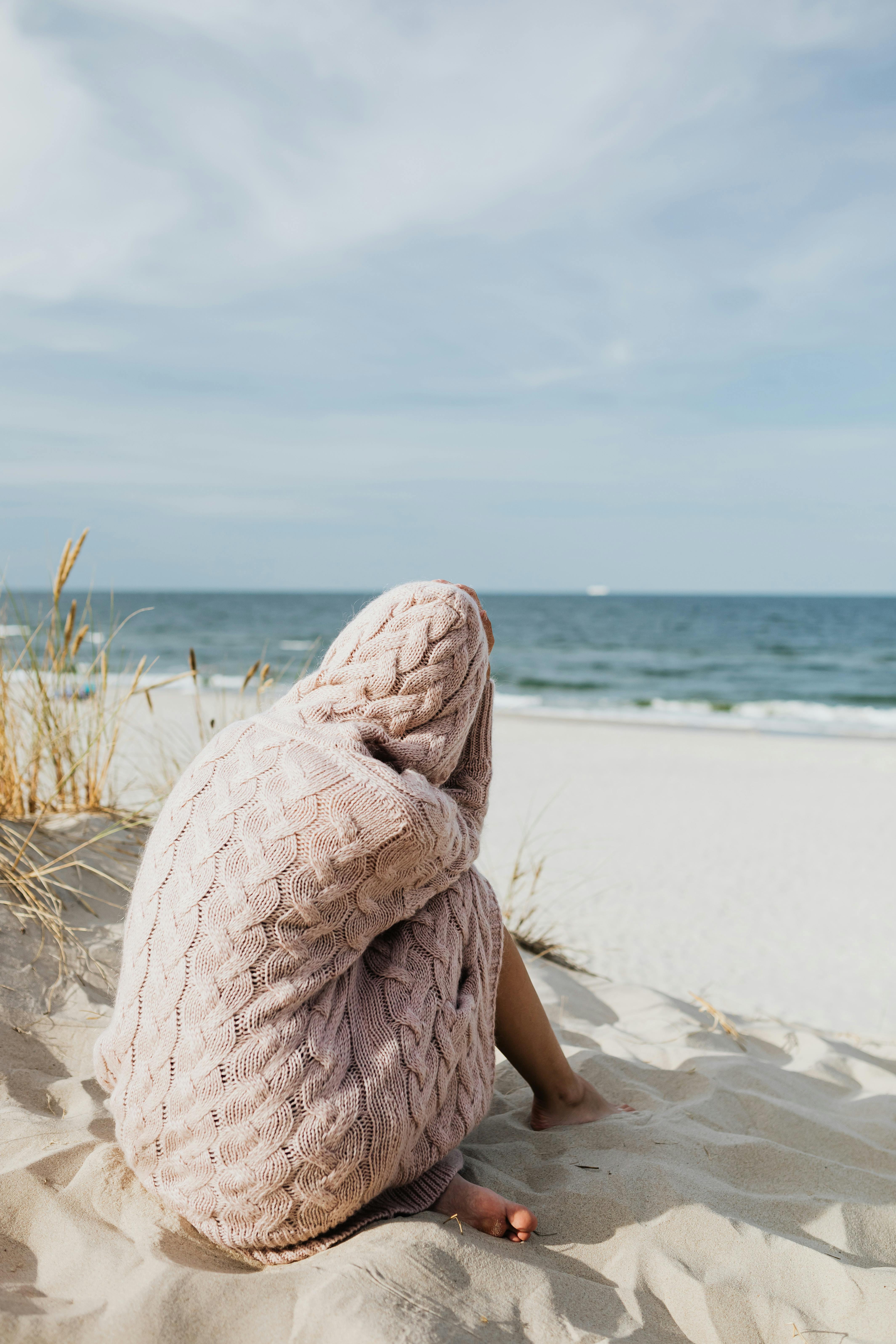 A Person Sitting on a Beach · Free Stock Photo
