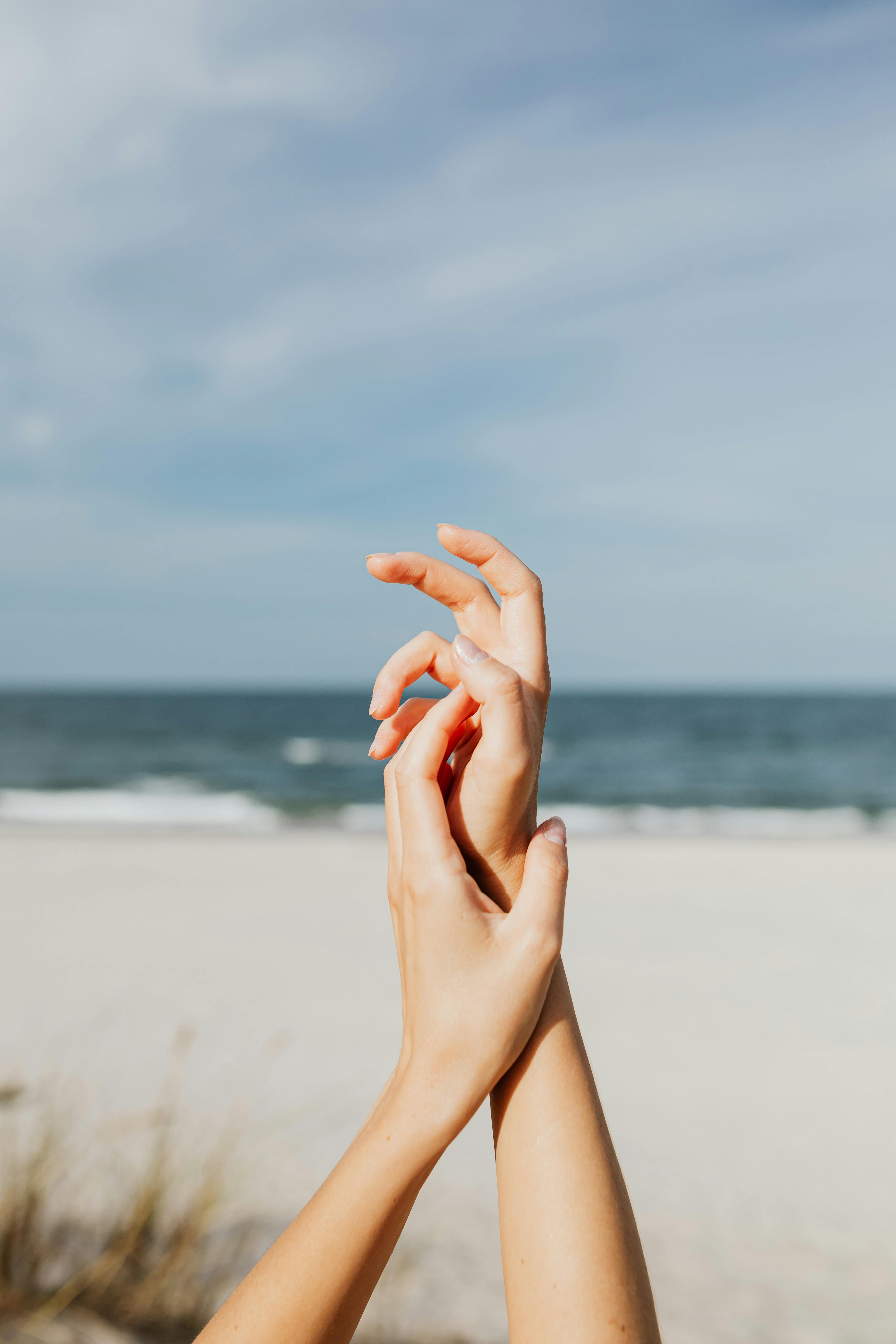 Person's Hand on the Beach · Free Stock Photo