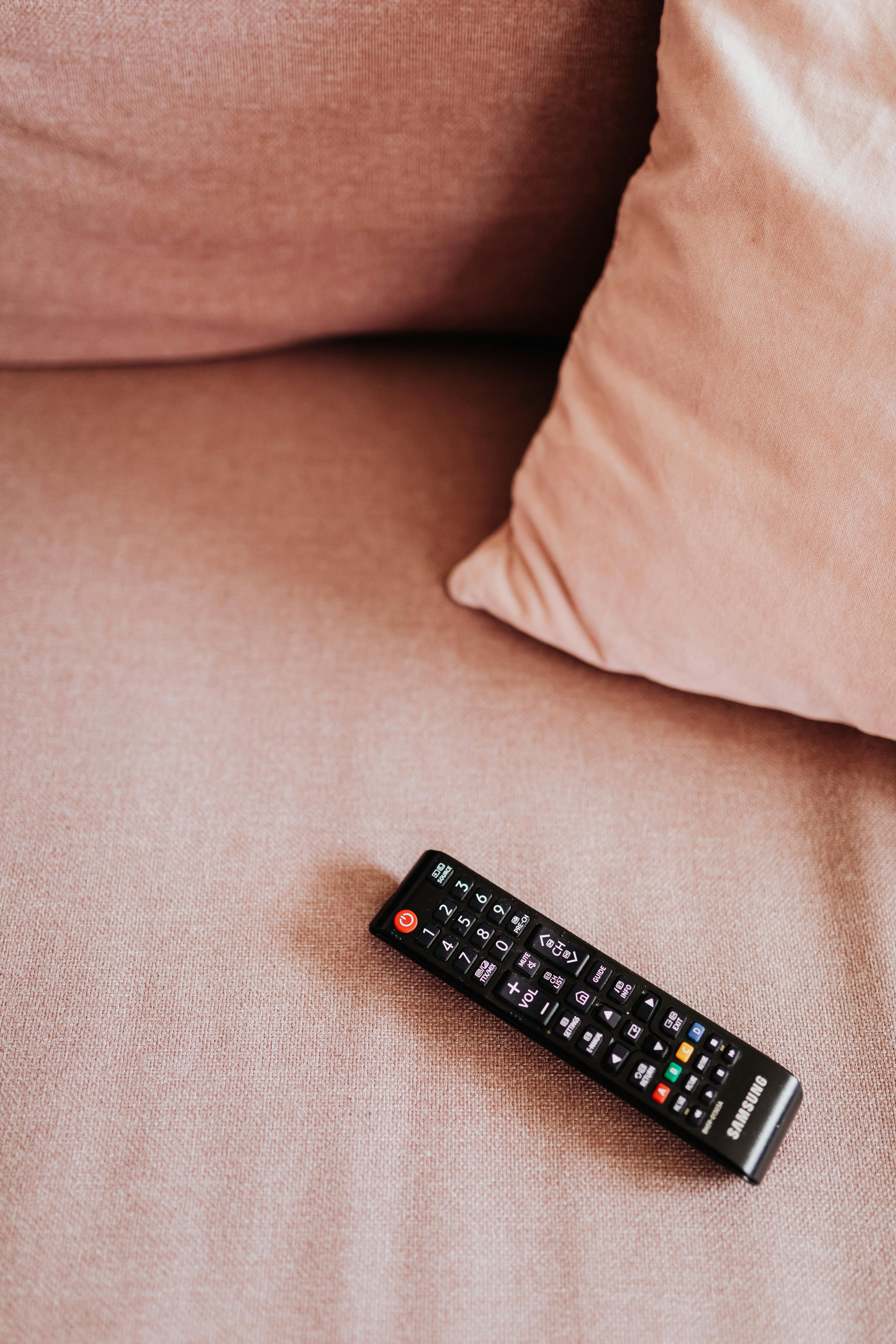 Black Remote Control on a Couch · Free Stock Photo