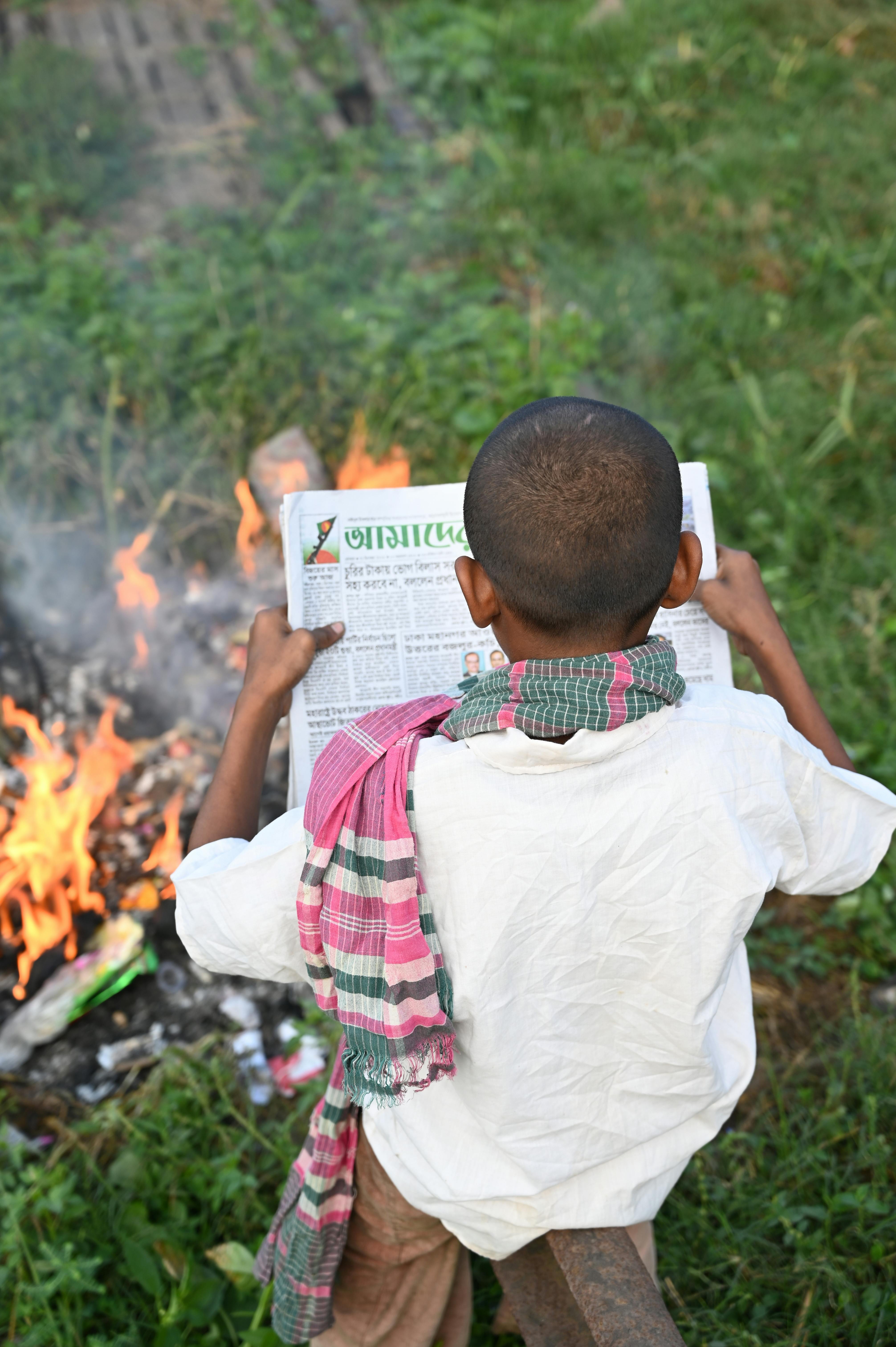 A Boy Reading Newspaper · Free Stock Photo