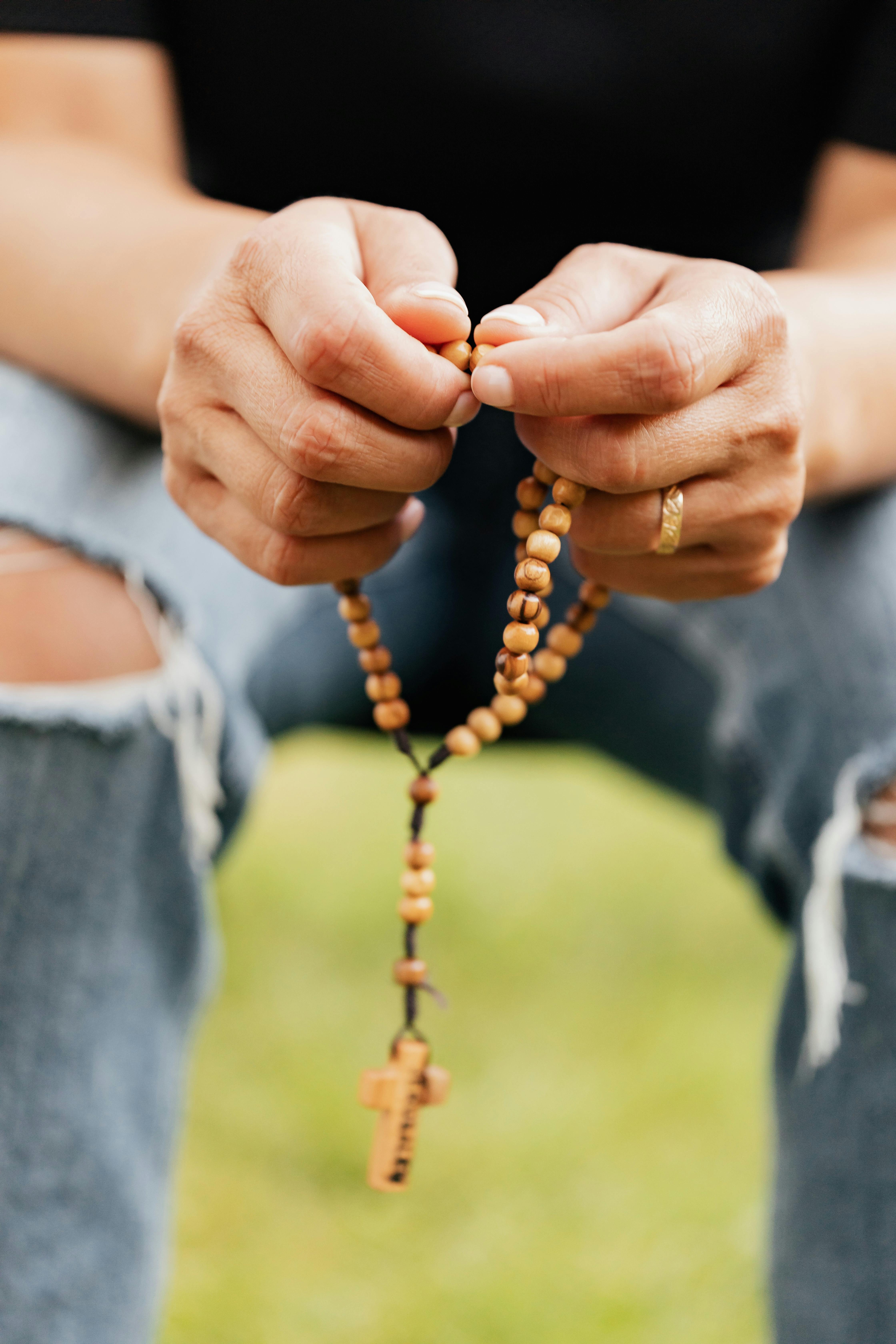 Close-Up Shot of a Person Holding a Rosary · Free Stock Photo