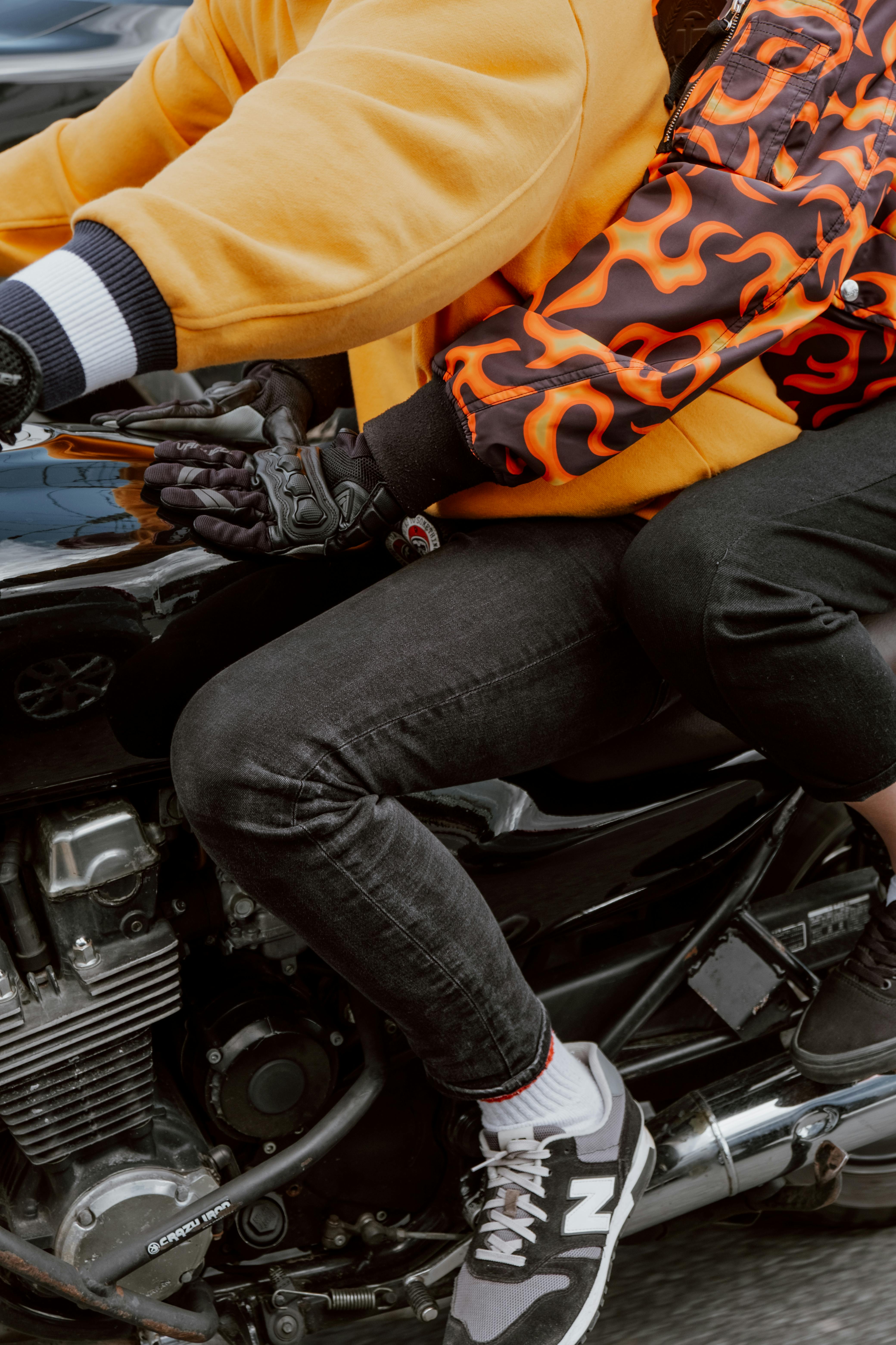 Close Up Shot of a Coupe Riding a Motorcycle · Free Stock Photo