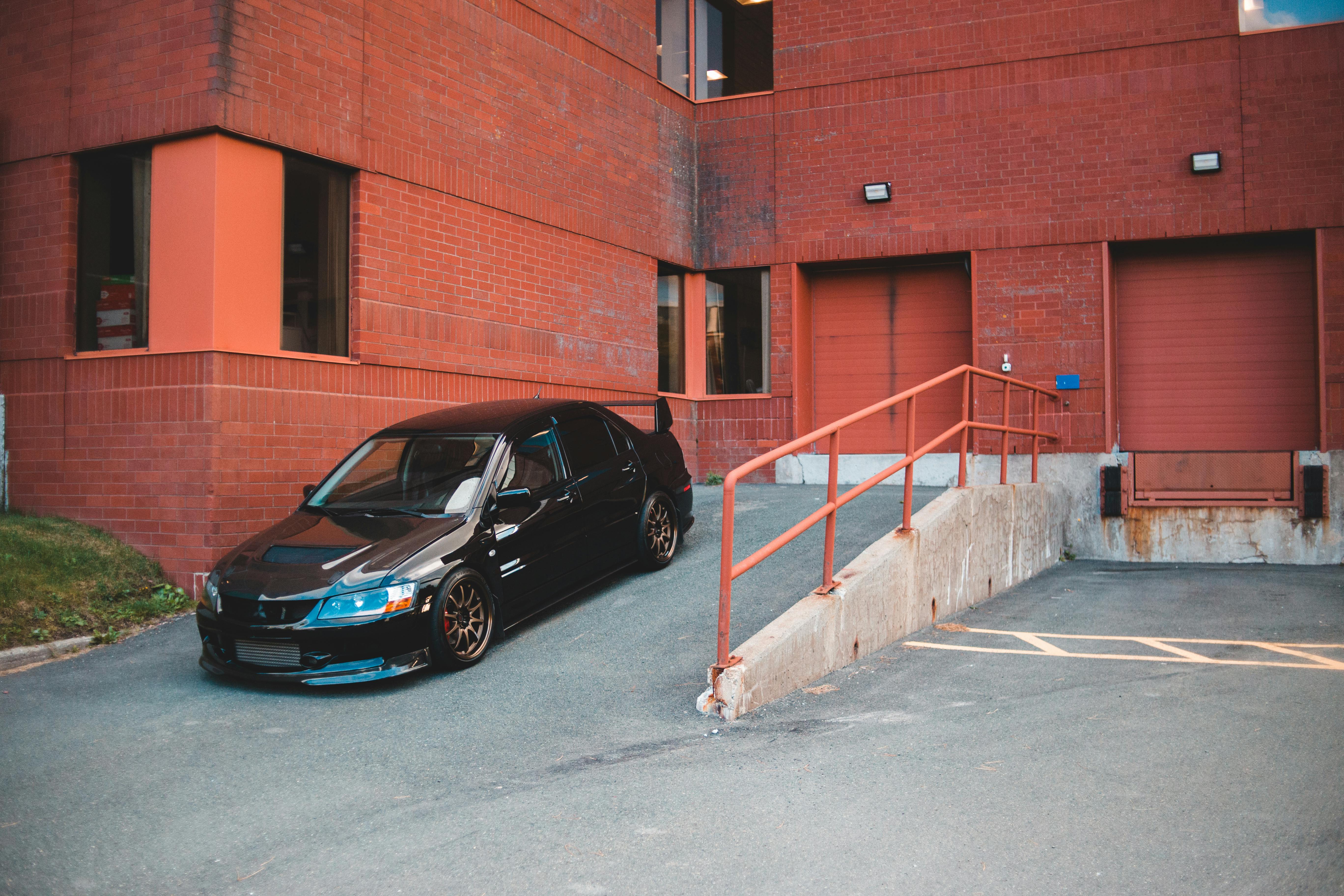 Modern car near industry building in city · Free Stock Photo