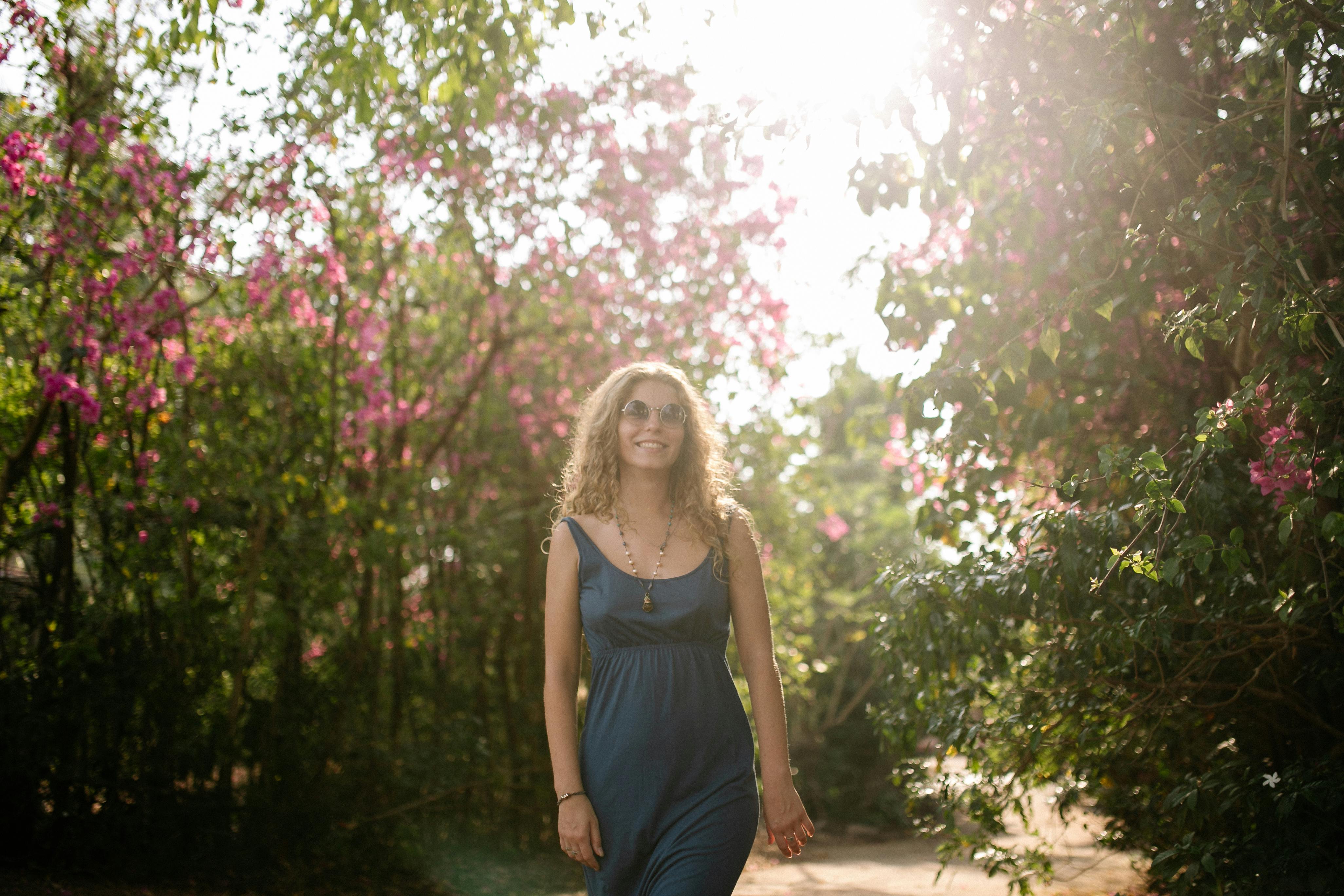 Woman Crouching among Pink Flowers · Free Stock Photo