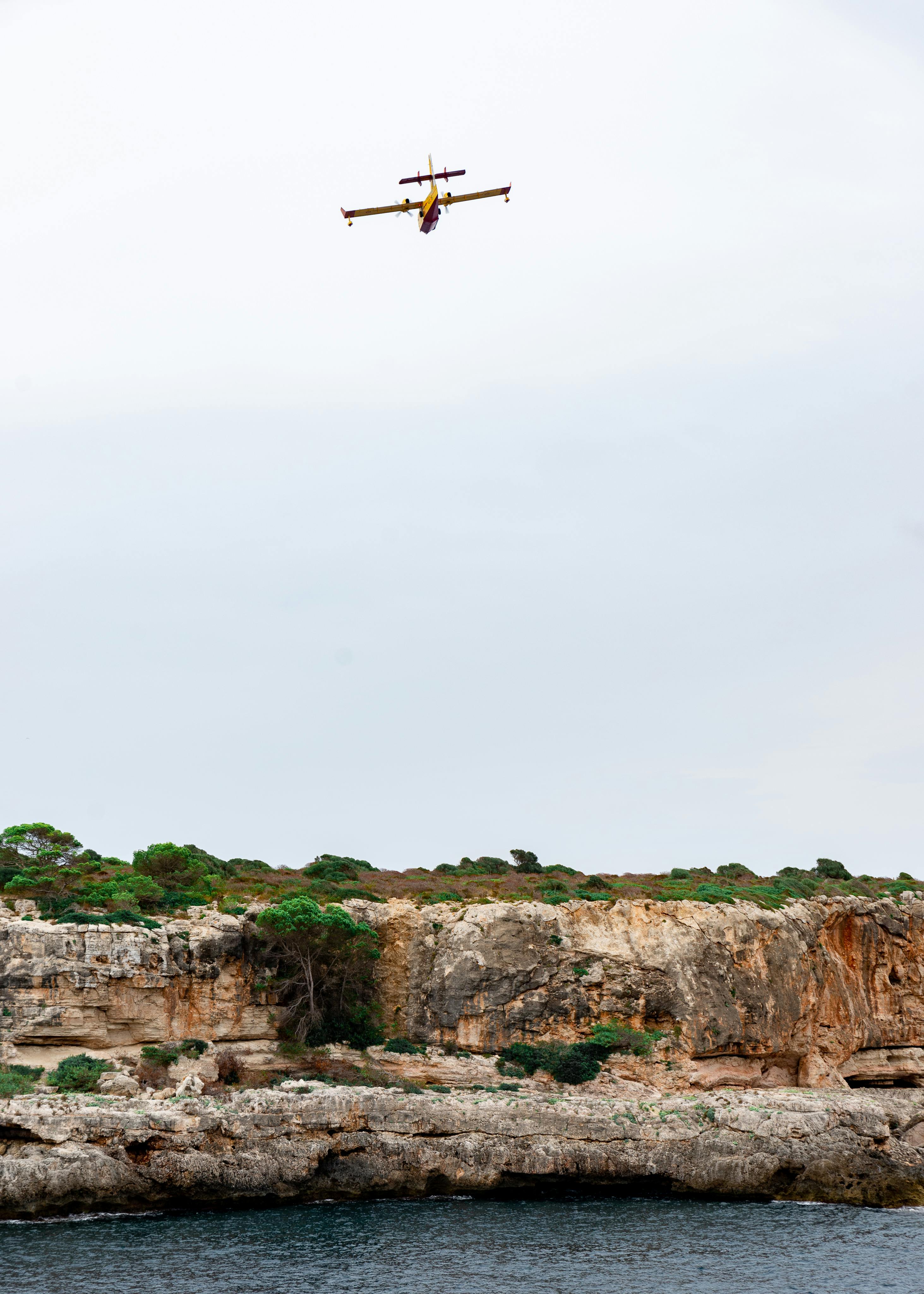Airplane Flying Over Cliff · Free Stock Photo