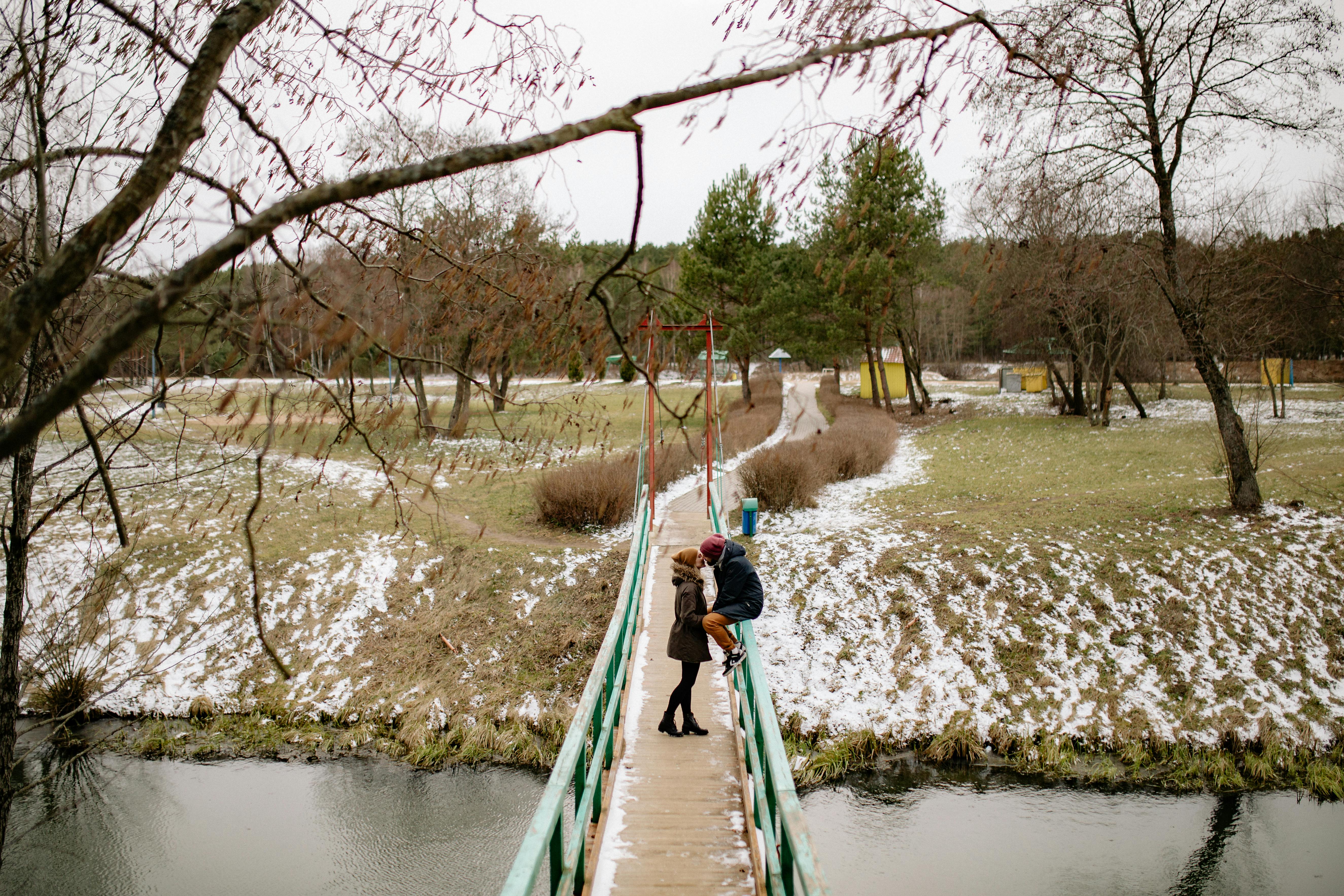 A Couple Kissing on a Bridge · Free Stock Photo