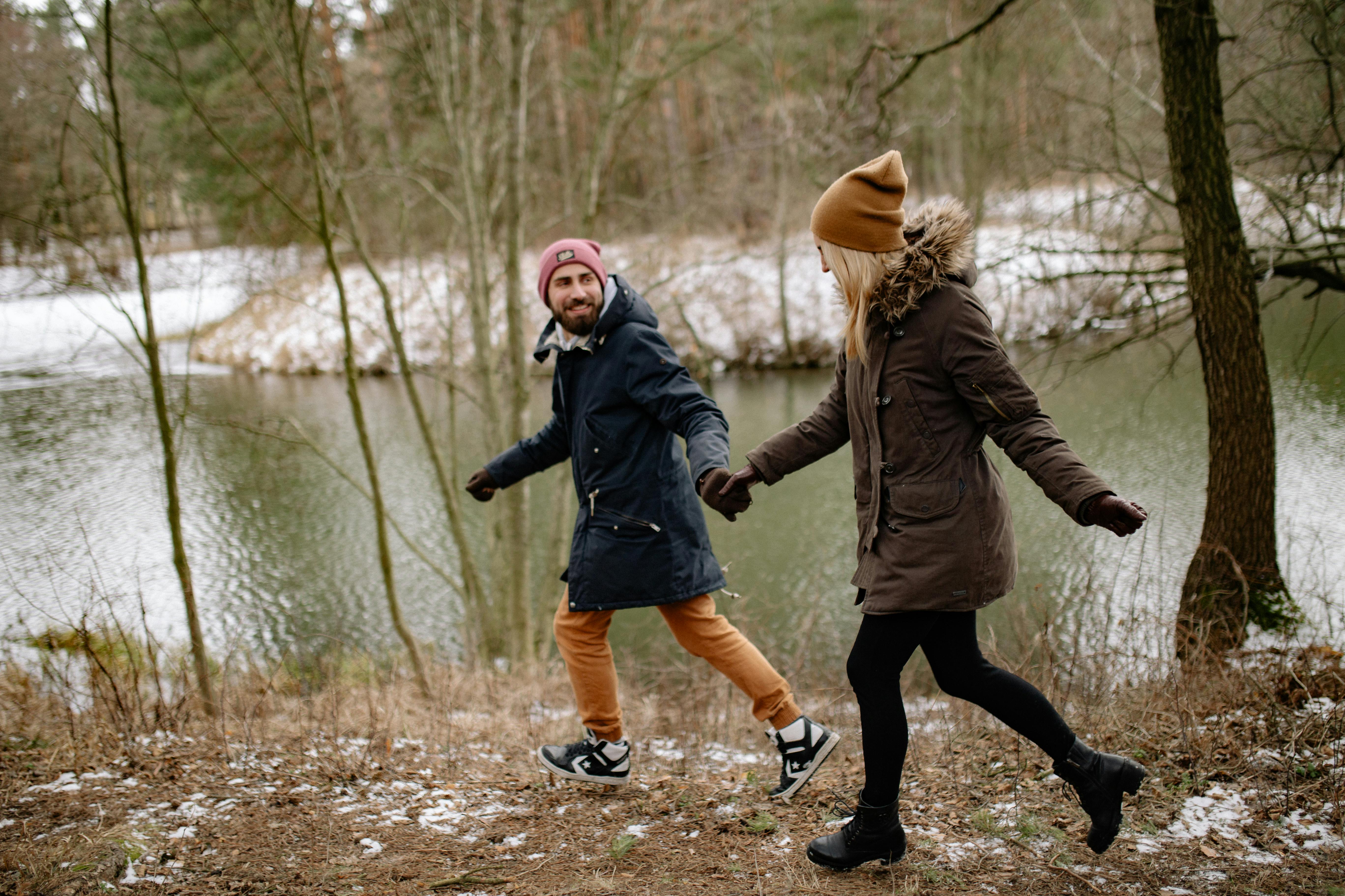 A Couple Holding Hands While Running · Free Stock Photo