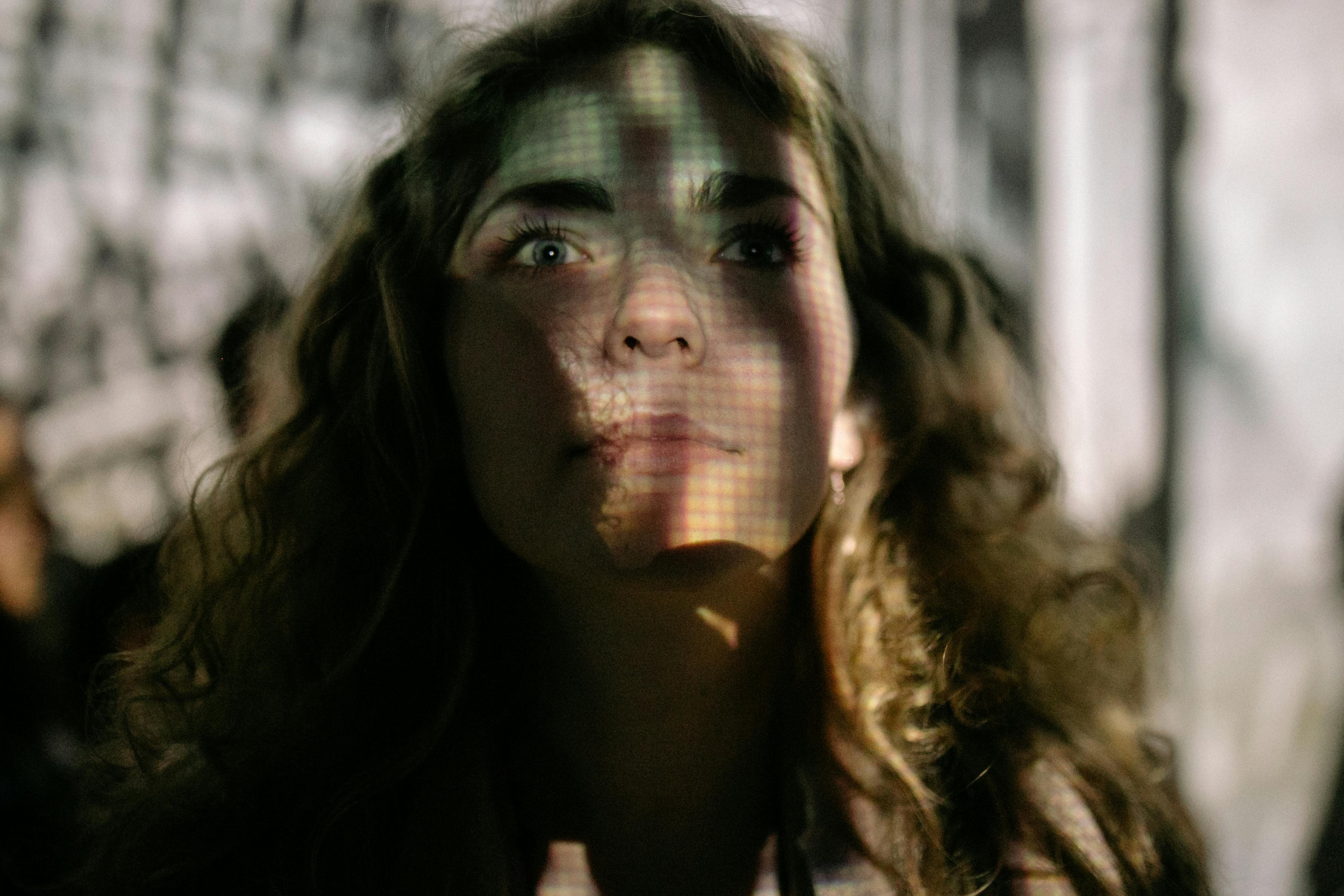 Portrait of Woman with Face Obscured by Shadows · Free Stock Photo