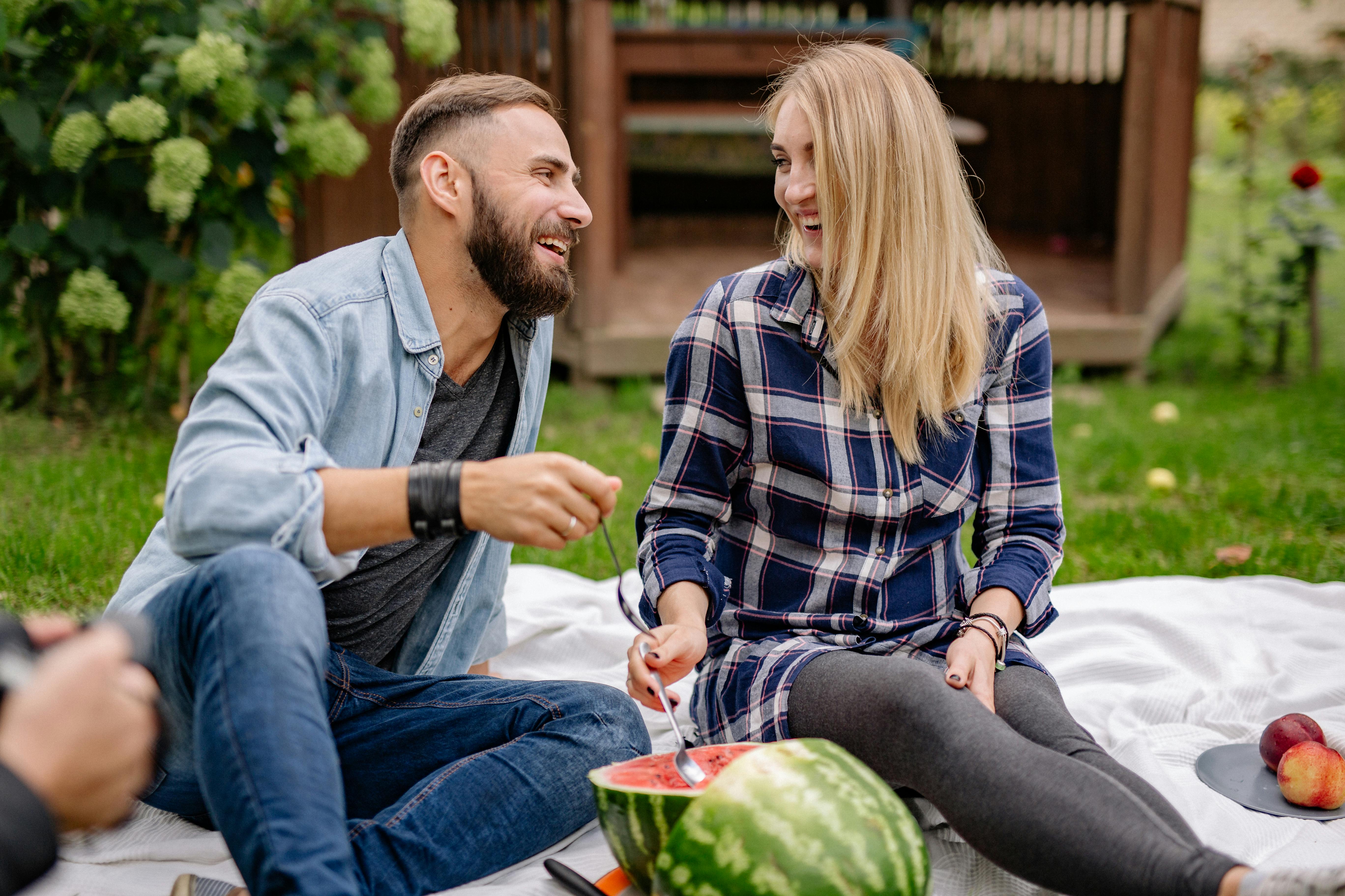 Man in Blue Denim Button Up Shirt Sitting Beside Woman in Blue and ...