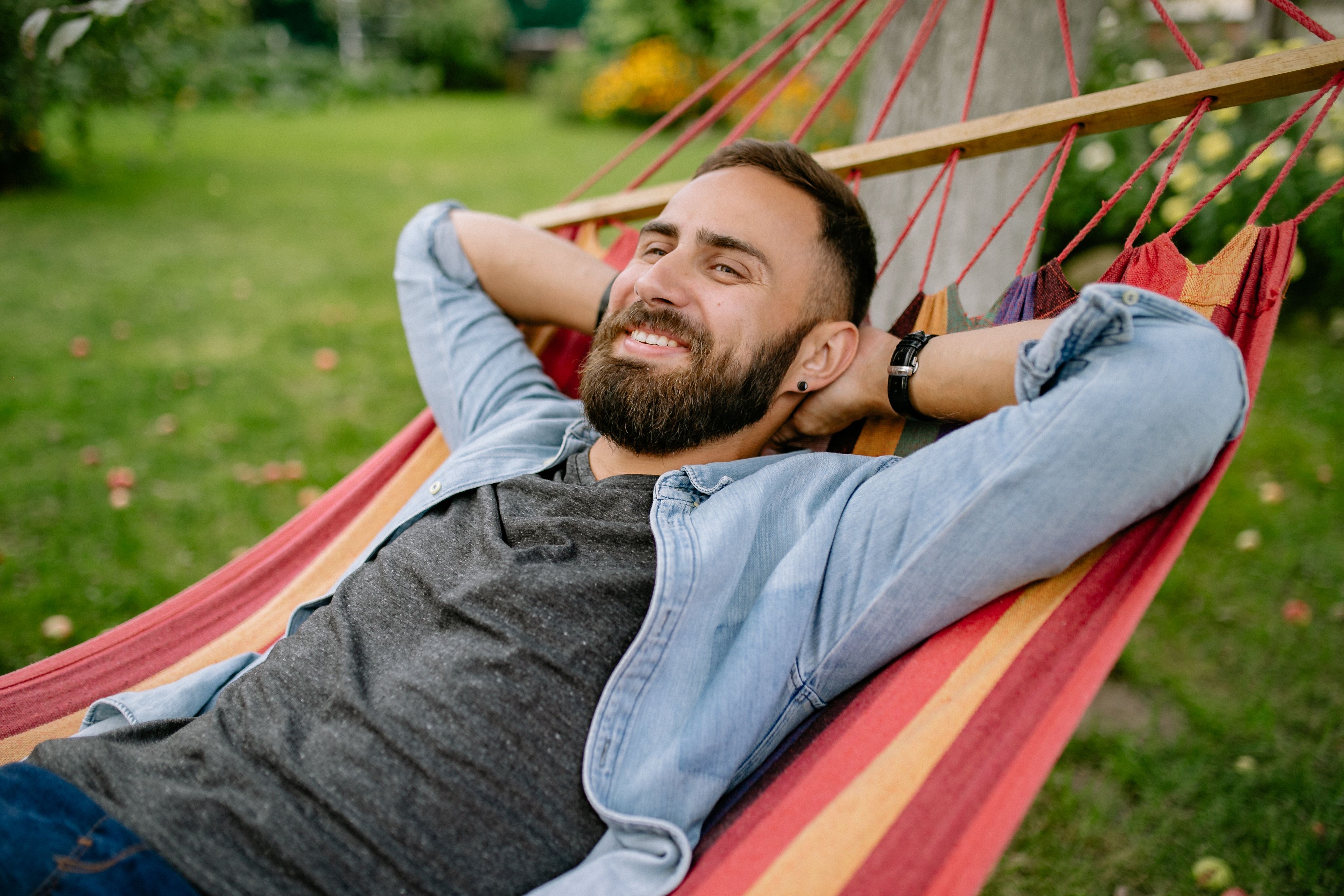 A Smiling Man Lying on a Hammock · Free Stock Photo