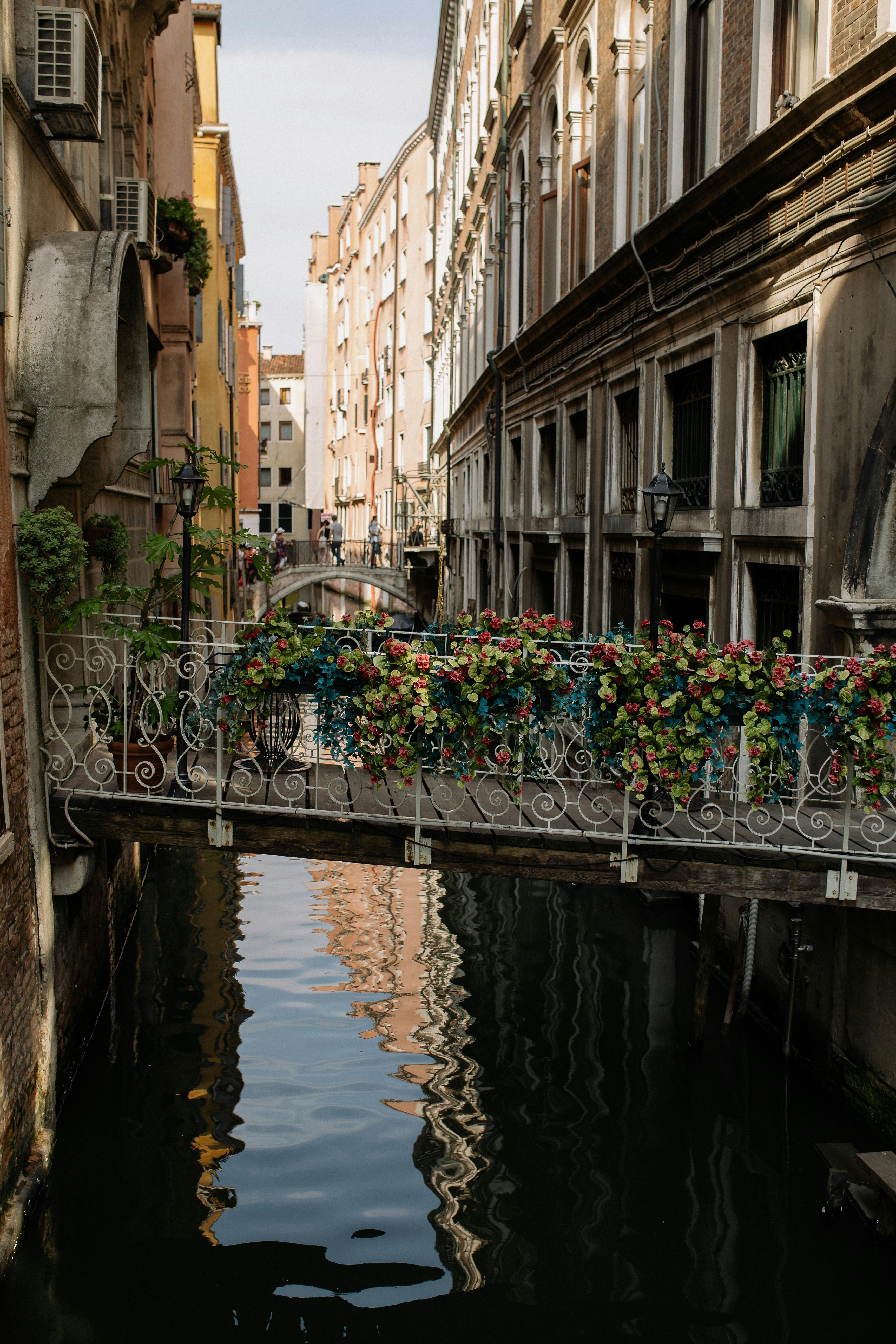 A Bridge on a Narrow Canal Between Buildings · Free Stock Photo