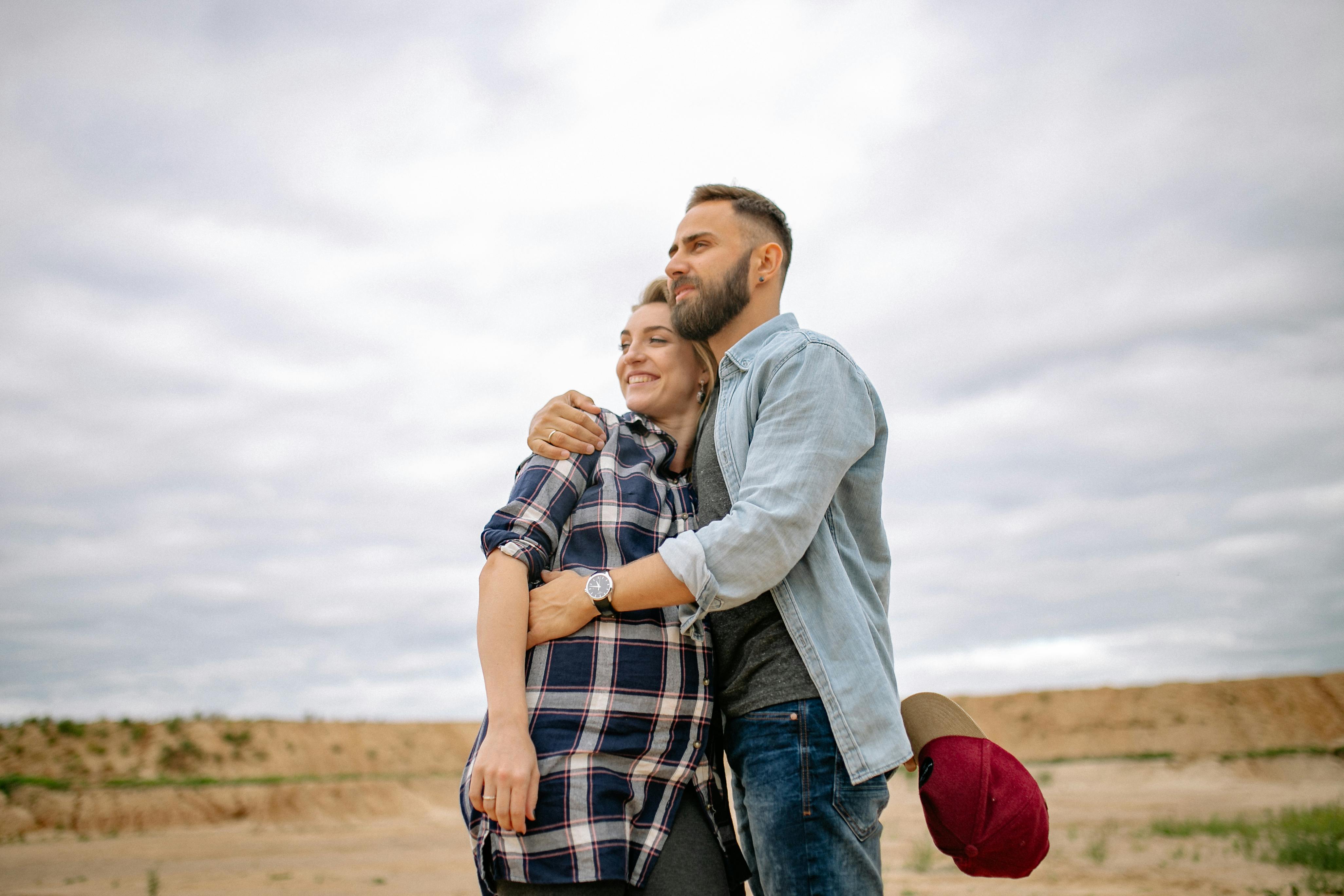 A Couple Embracing while Standing on the Desert · Free Stock Photo