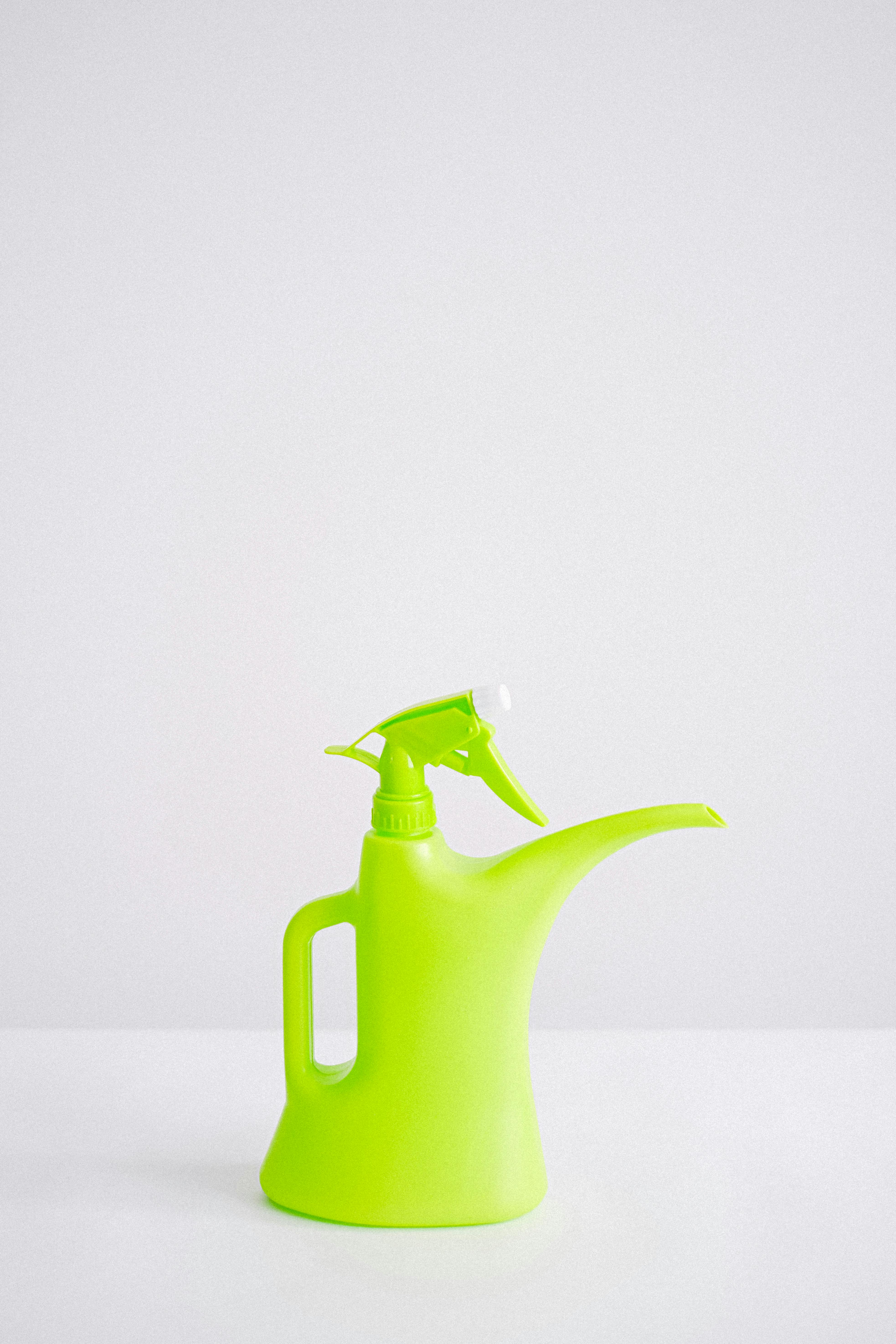 Green Spray Bottle on White Surface · Free Stock Photo
