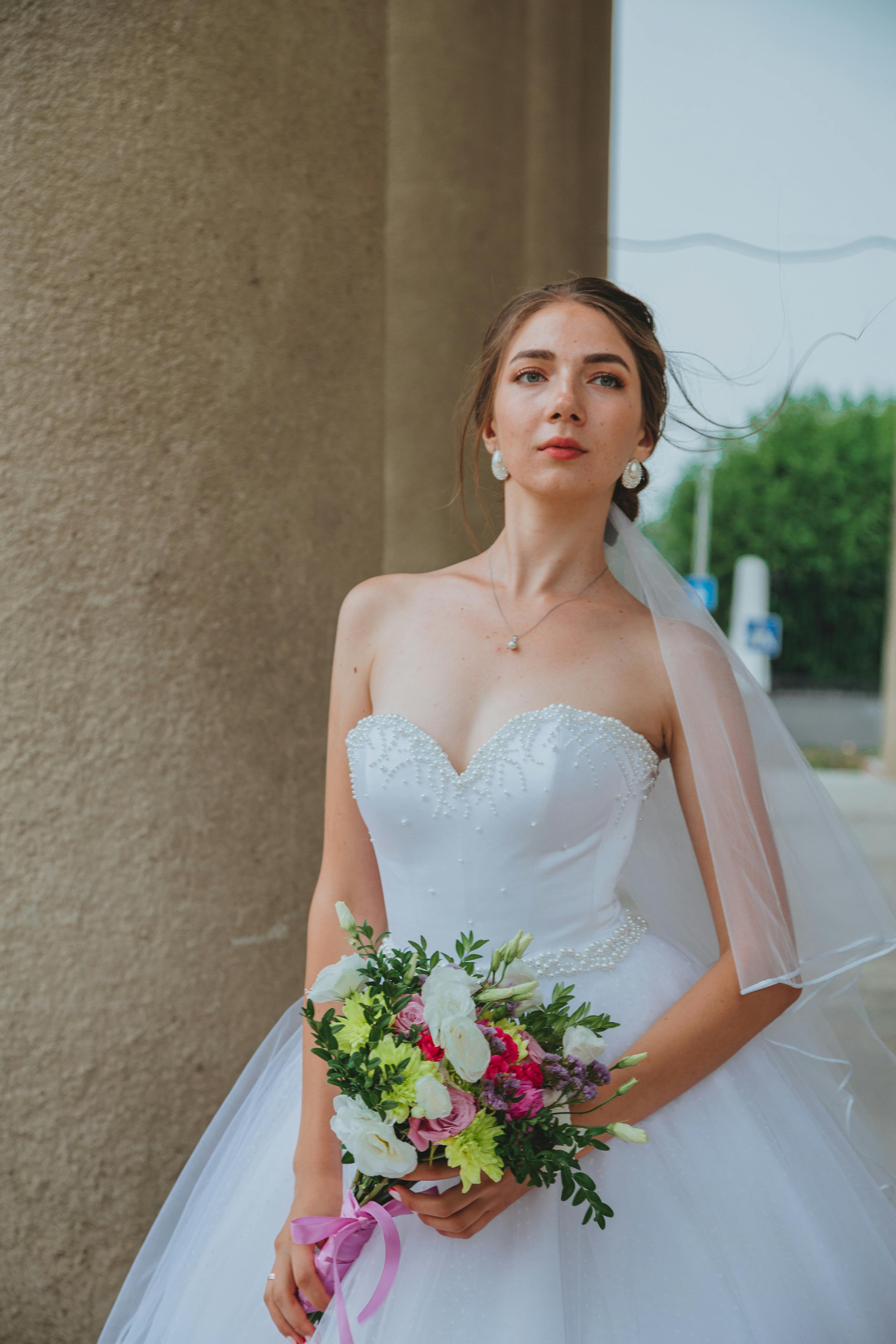 Elegant woman with flowers on wedding day · Free Stock Photo
