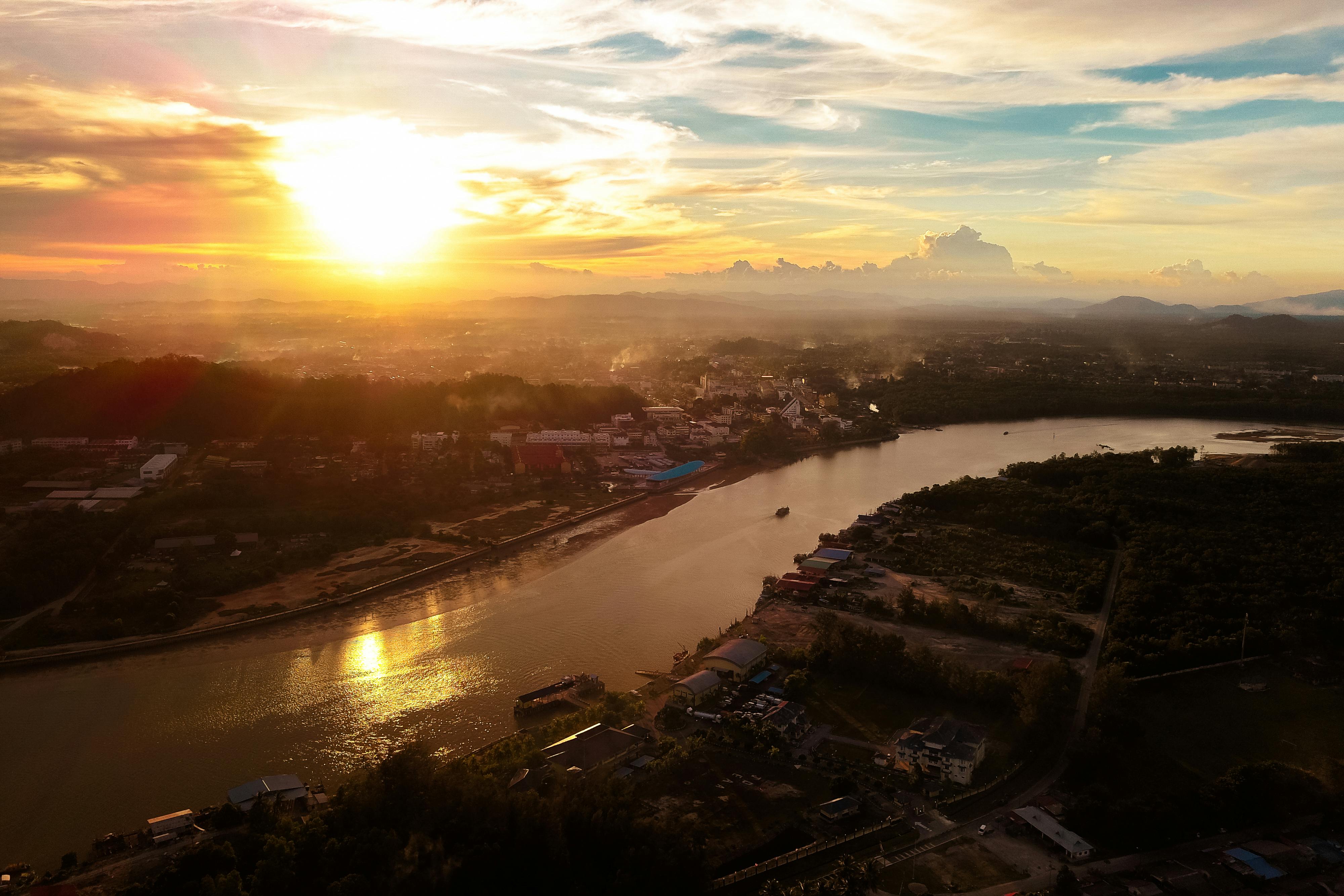 Cityscape of town with river at sunset · Free Stock Photo