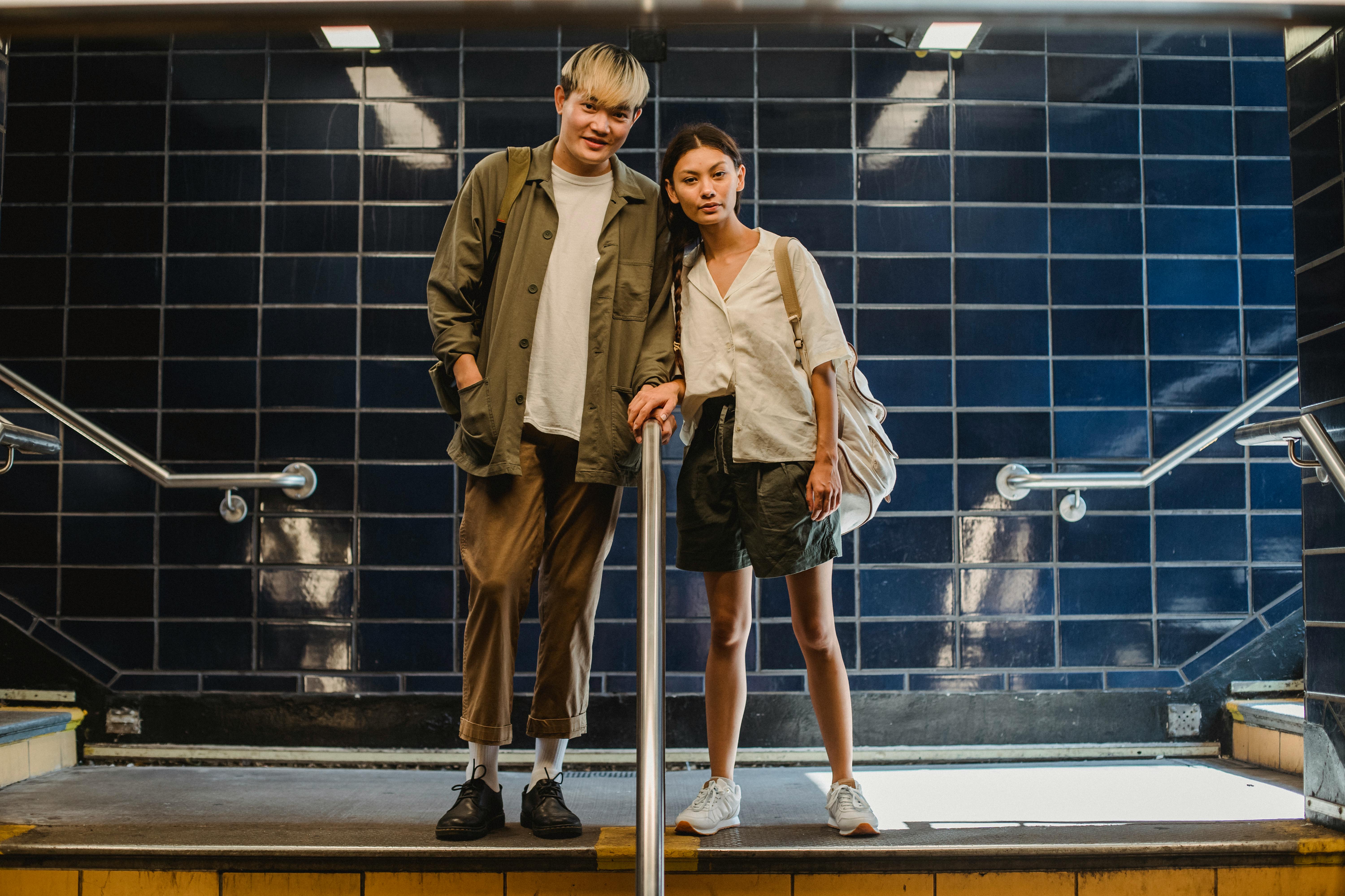 Stylish millennial couple standing in passage · Free Stock Photo