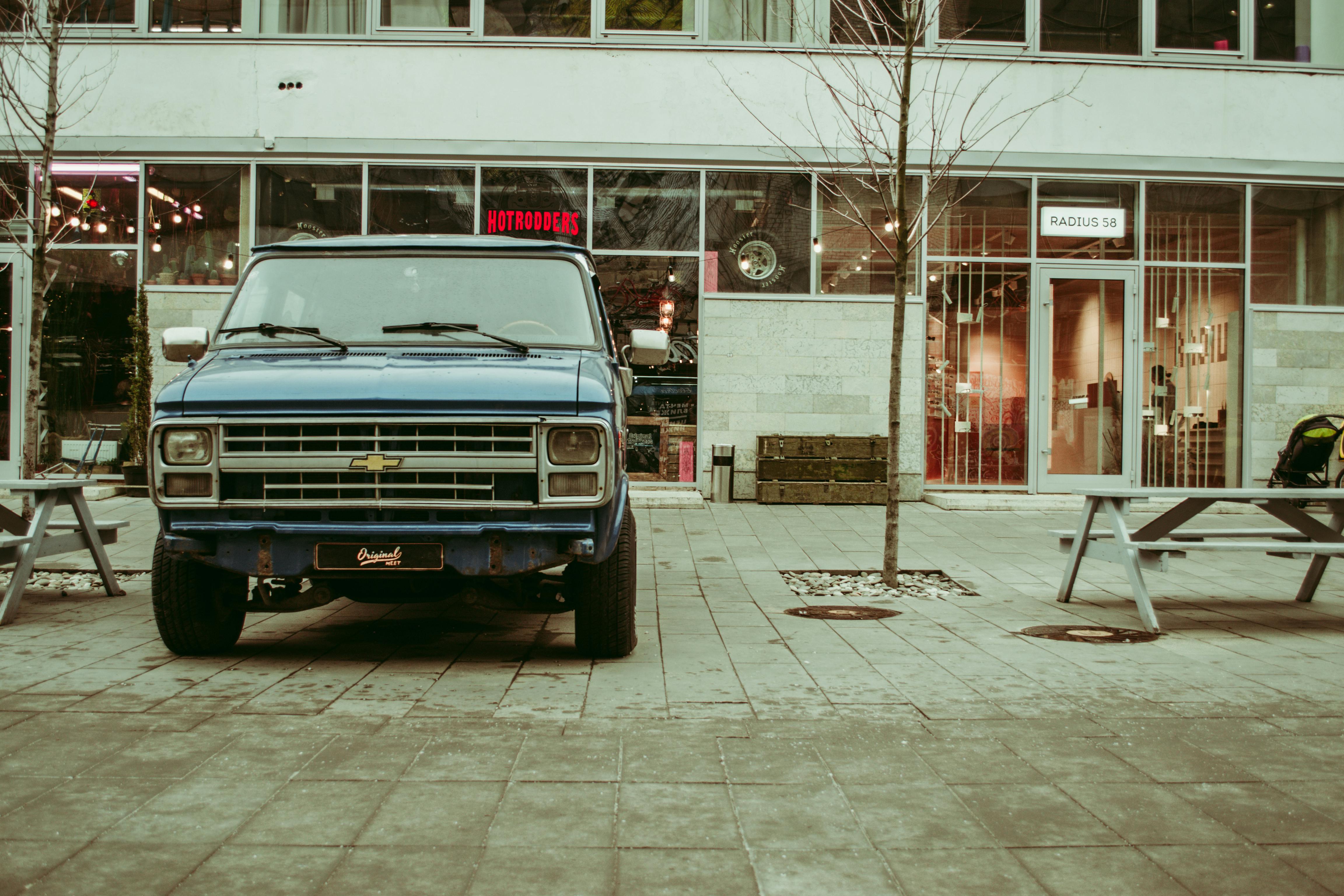 Old ATV vehicle on pavement against urban shop · Free Stock Photo