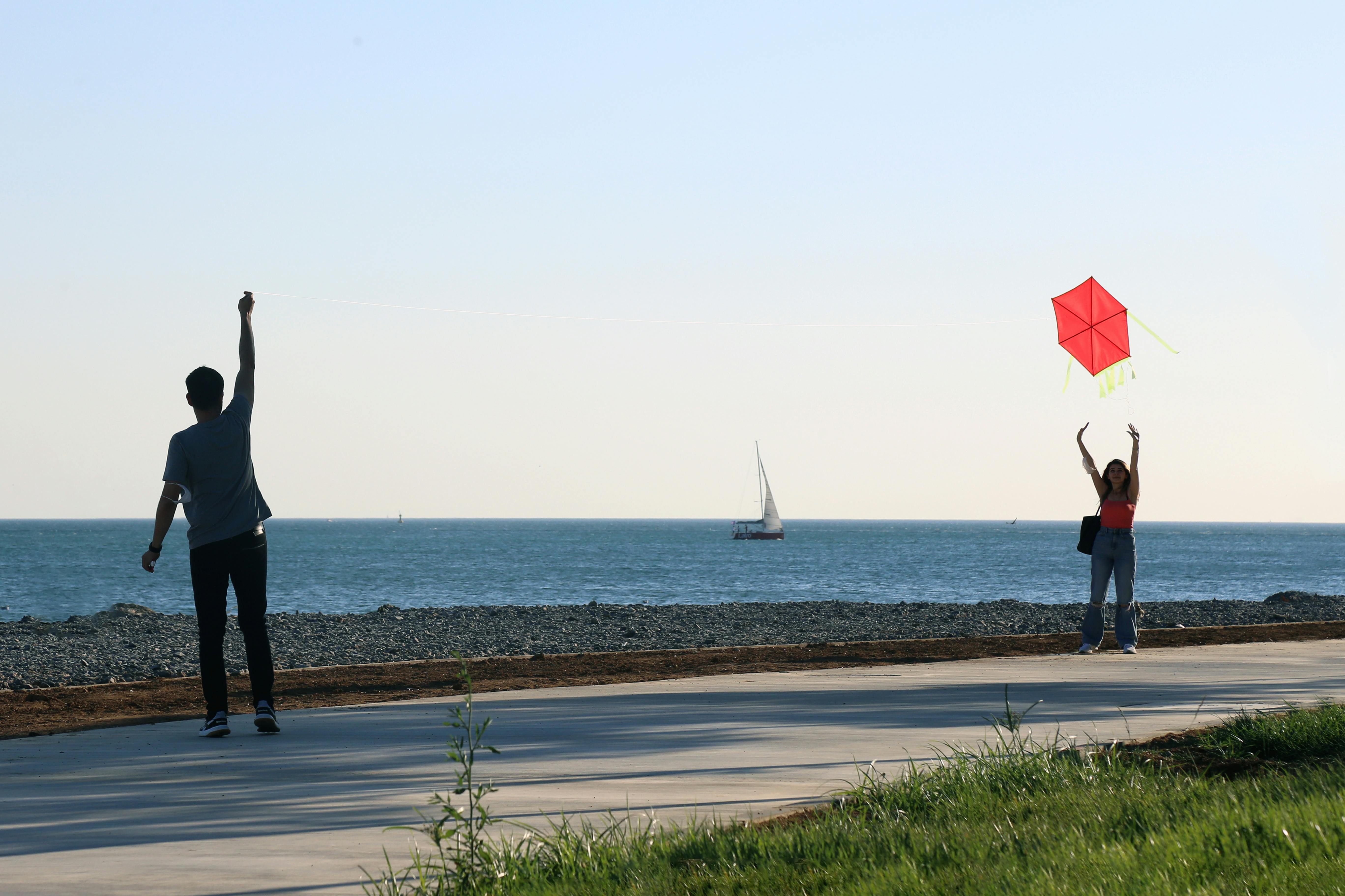 Man and Woman Flying a Kite · Free Stock Photo