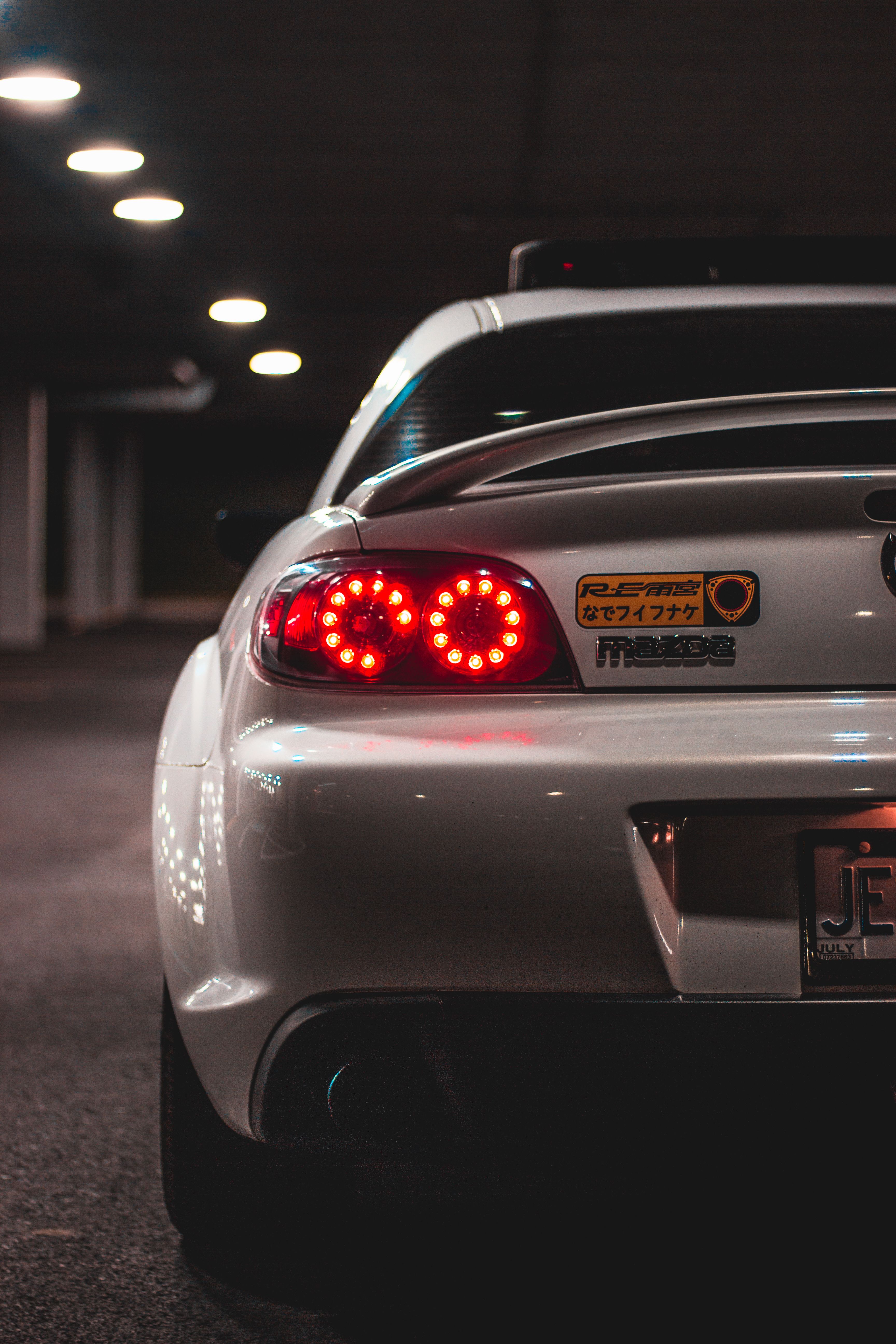 Contemporary racing car parked on road on cloudy day · Free Stock Photo