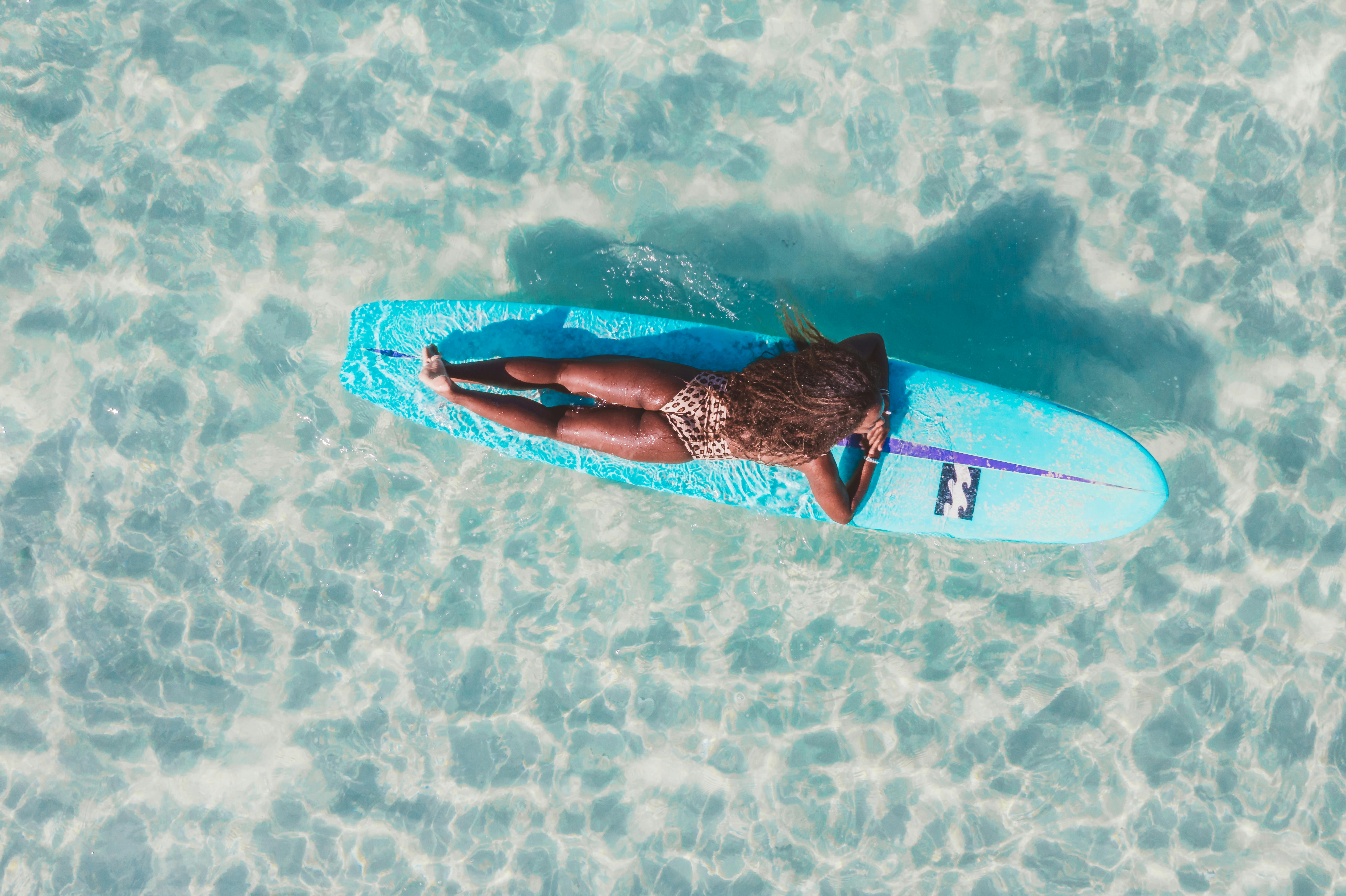 A Woman Prone Position in a Surfboard · Free Stock Photo