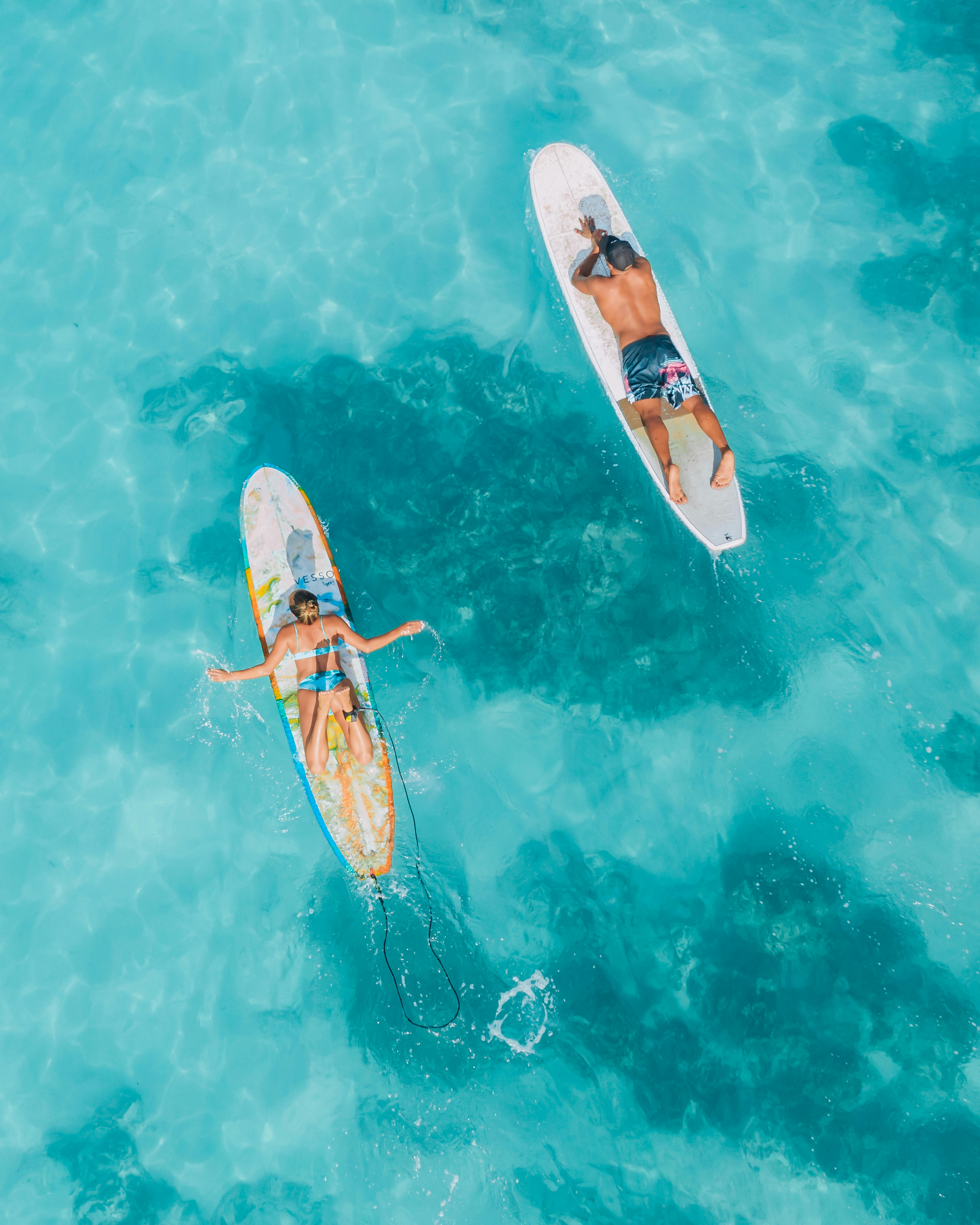 Surf Boarders Floating on Turquoise Seawater · Free Stock Photo