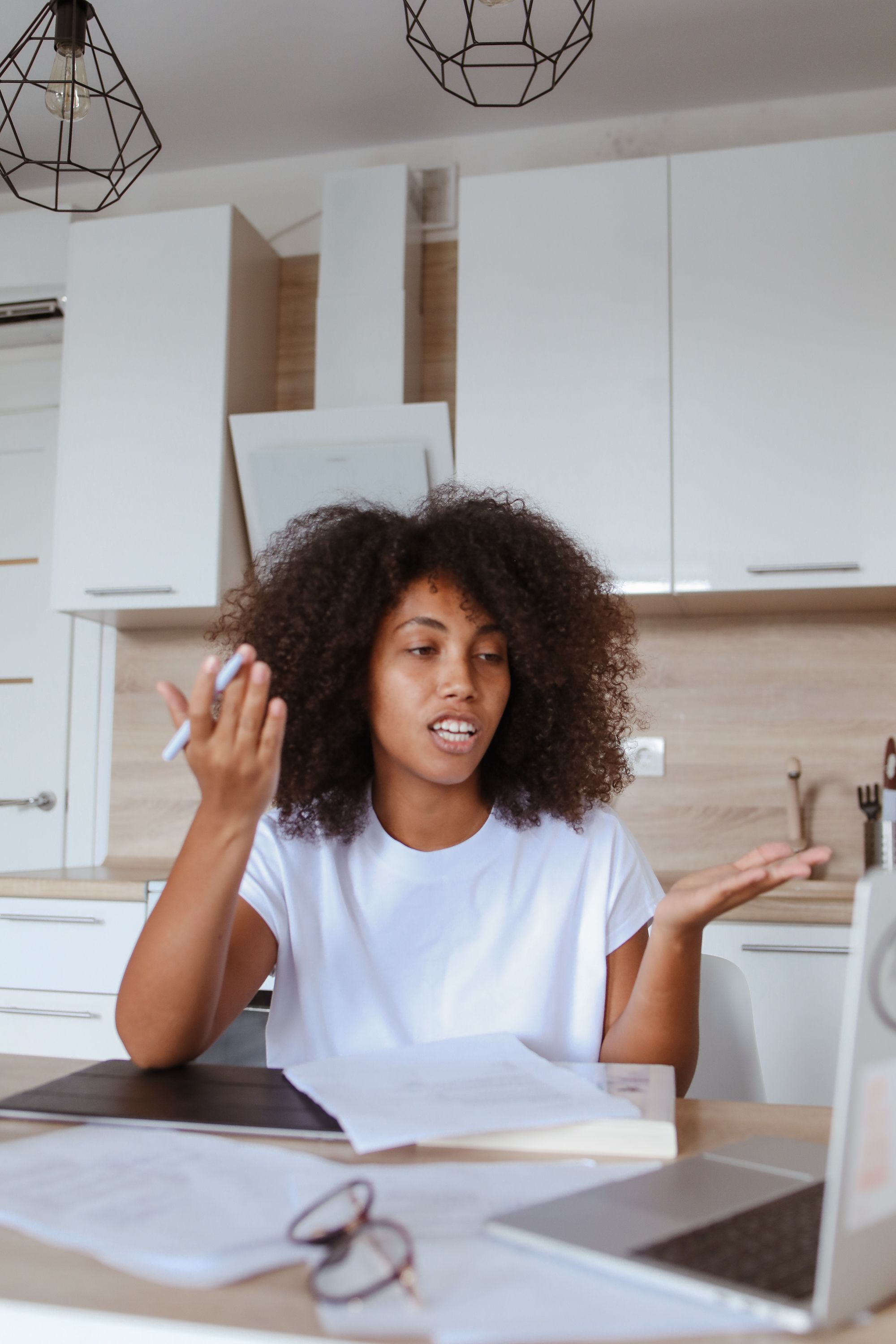 Young Woman in White Shirt Sitting and Having Video Call Conversation ...